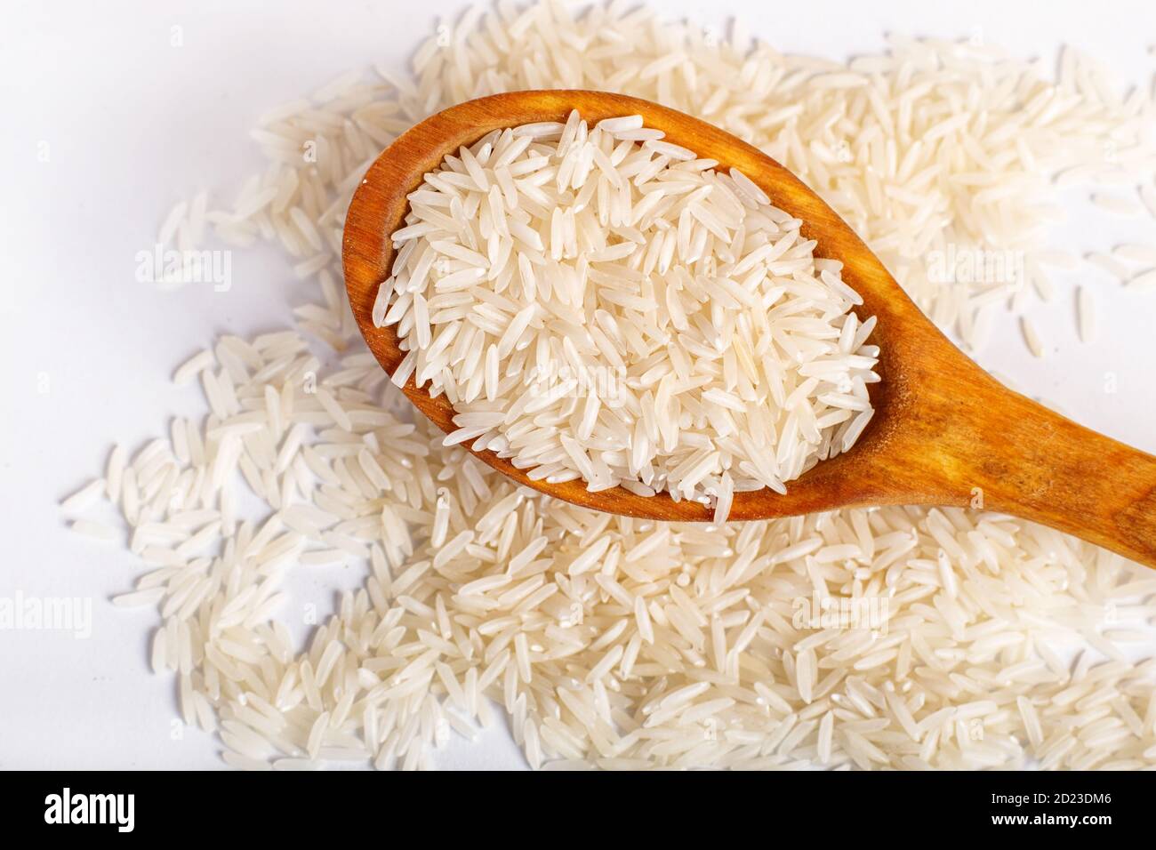 Pile of basmati rice in a wooden spoon isolated on white background ...