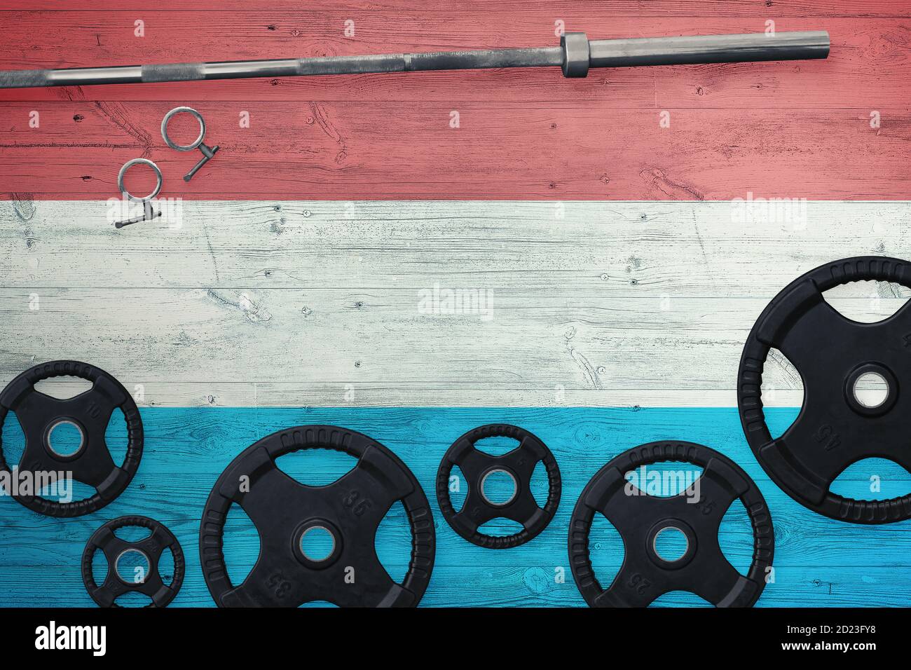 Luxembourg gym concept. Top view of heavy weight plates with iron bar ...