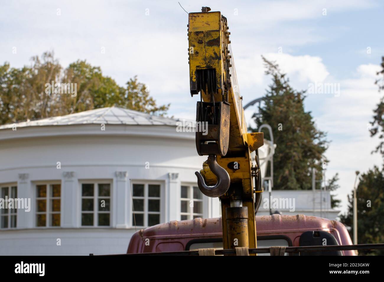 Small truck with loader crane for unloading construction materials at a ...