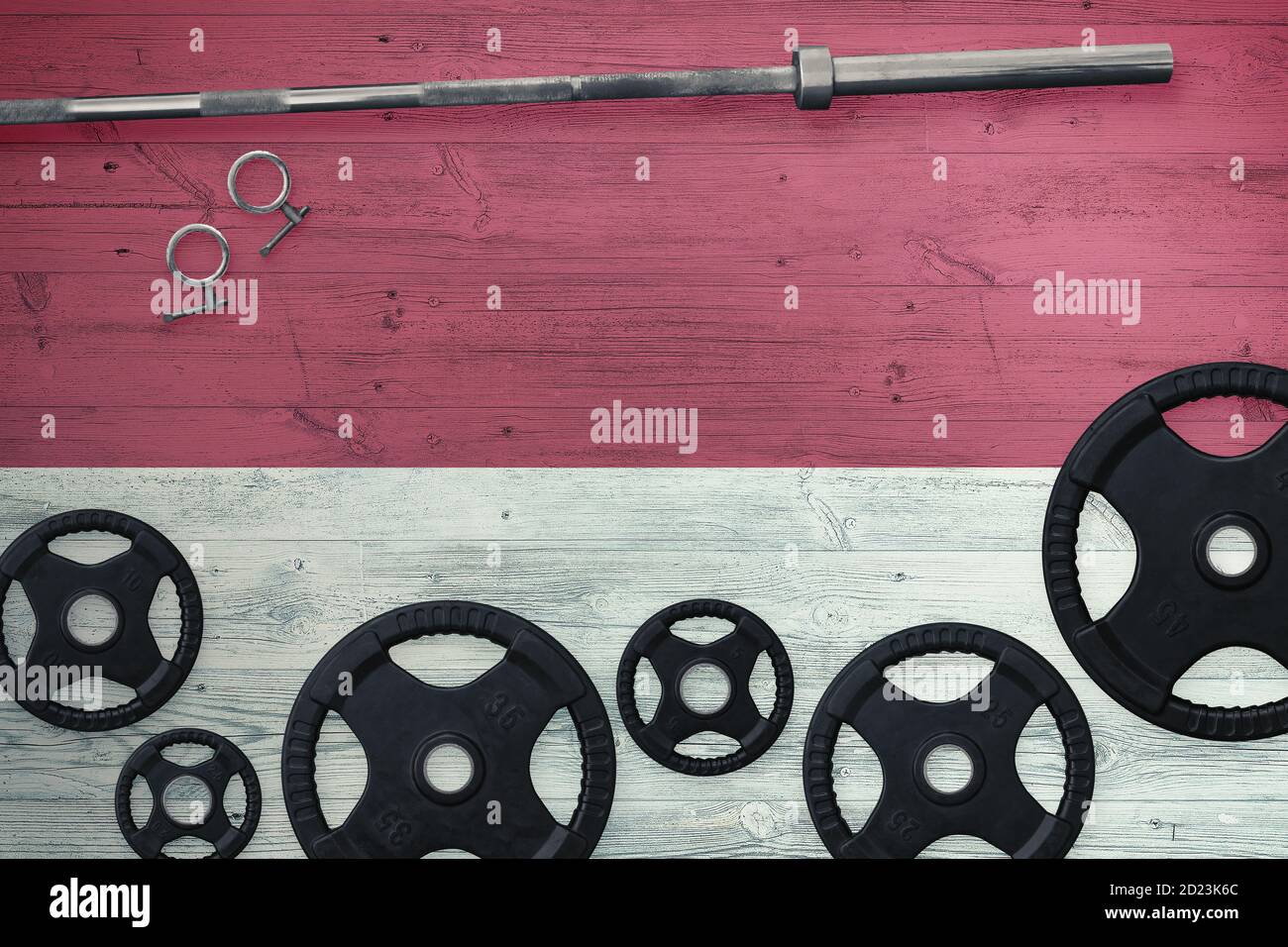 Monaco gym concept. Top view of heavy weight plates with iron bar on ...