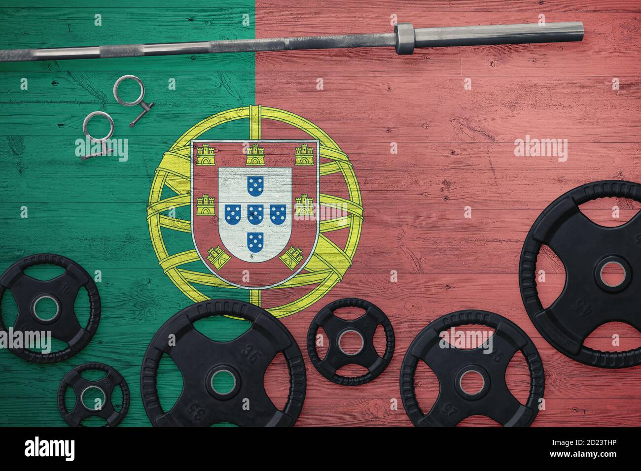 Portugal gym concept. Top view of heavy weight plates with iron bar on ...