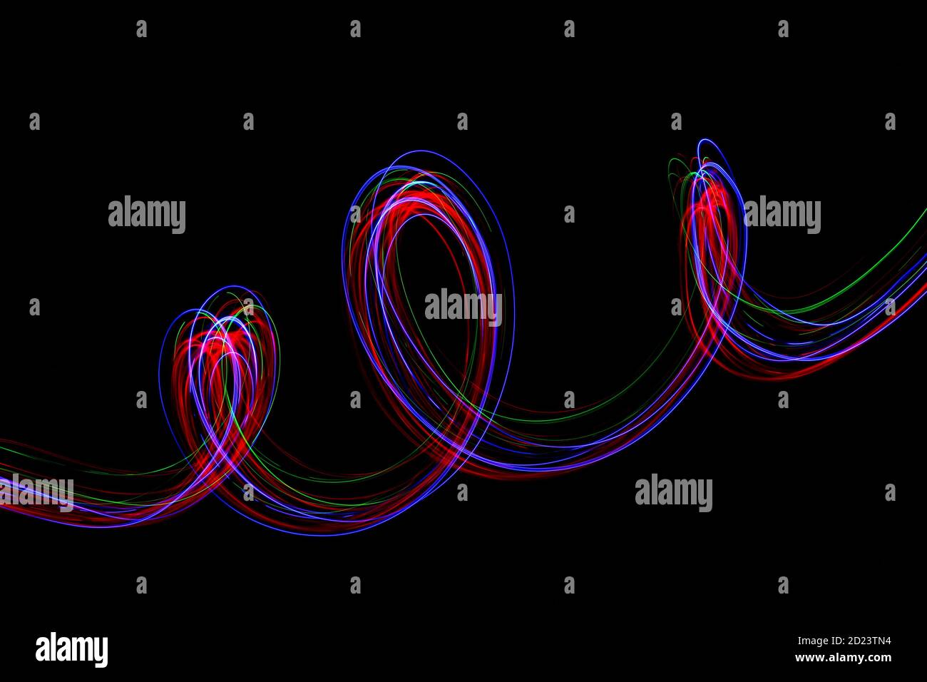 Long exposure photograph of neon colour in an abstract swirl, parallel ...