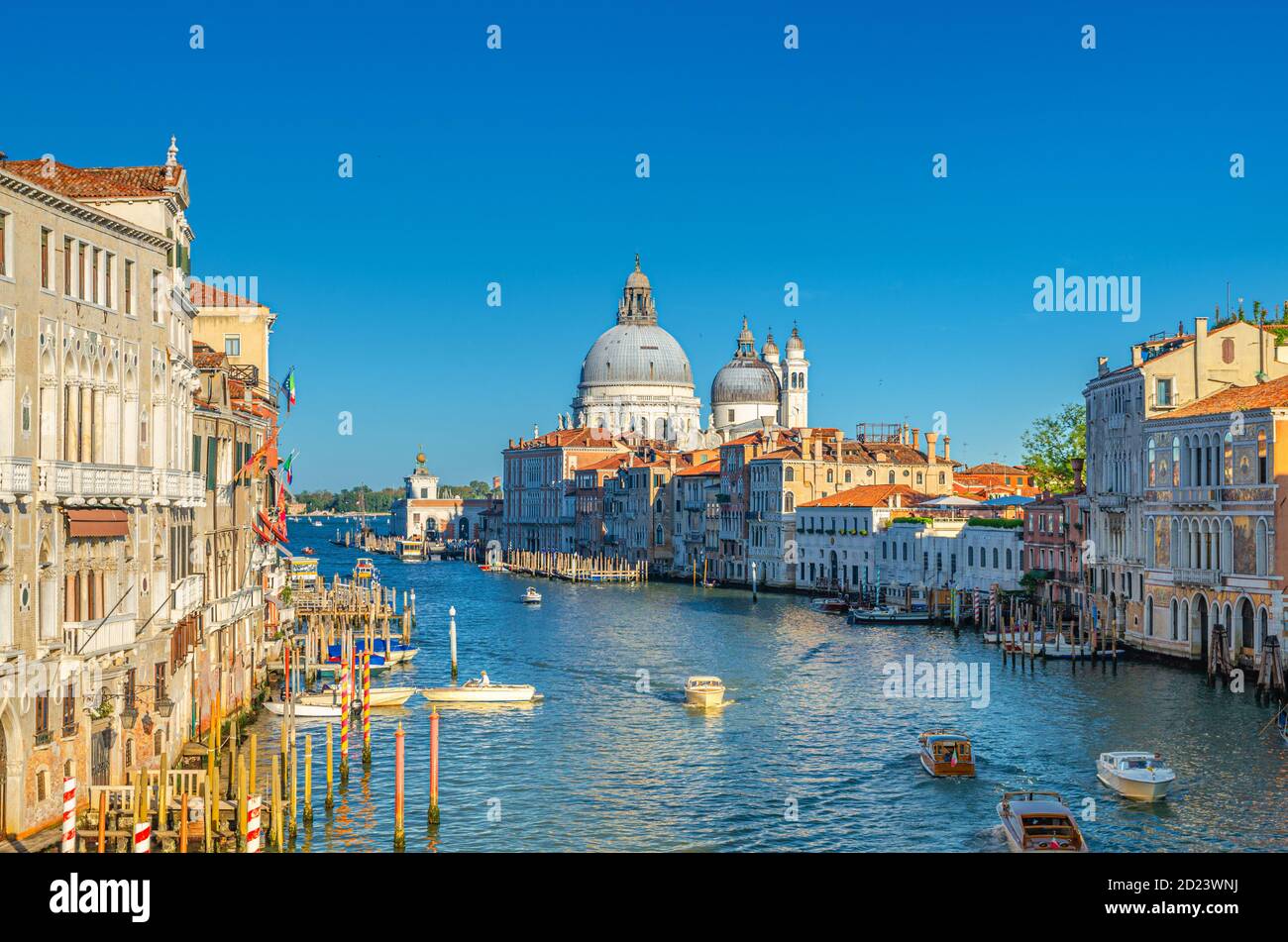 Venice cityscape with Grand Canal waterway. Gondolas and boats docked ...