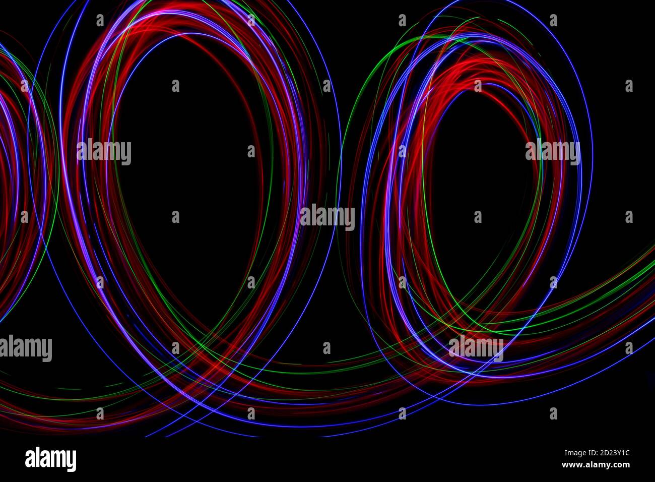 Long exposure photograph of neon colour in an abstract swirl, parallel ...