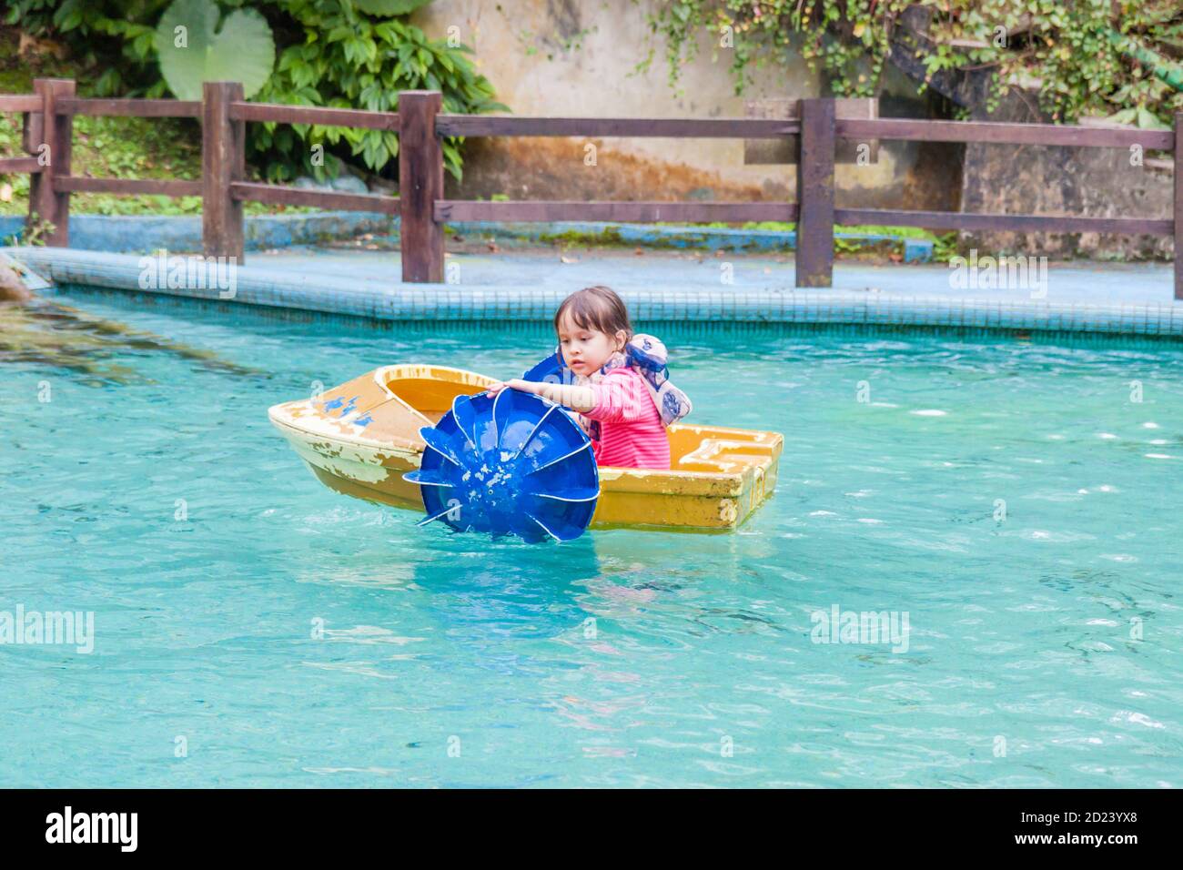 Young girl in hand paddle boat Stock Photo - Alamy