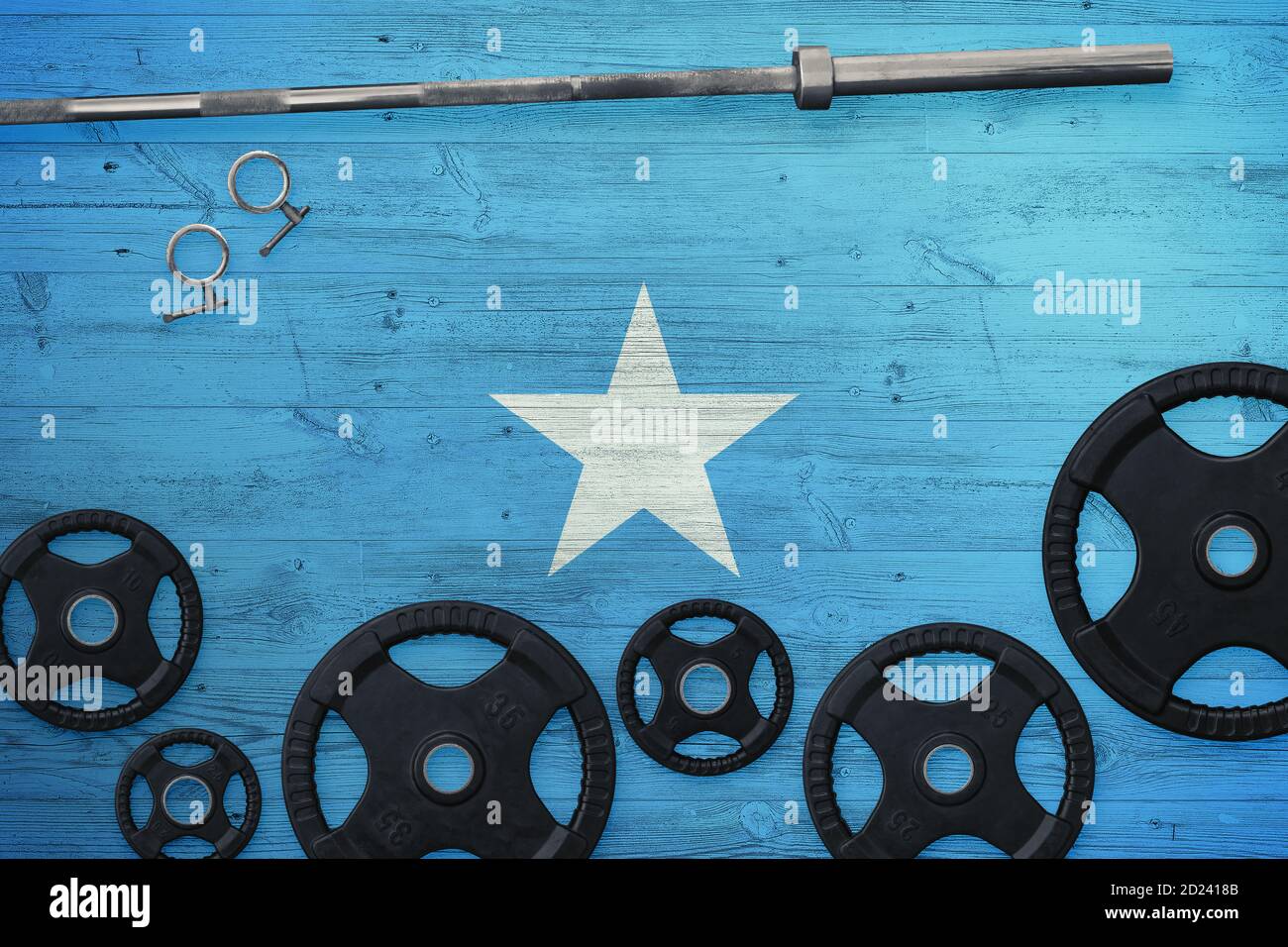 Somalia gym concept. Top view of heavy weight plates with iron bar on ...
