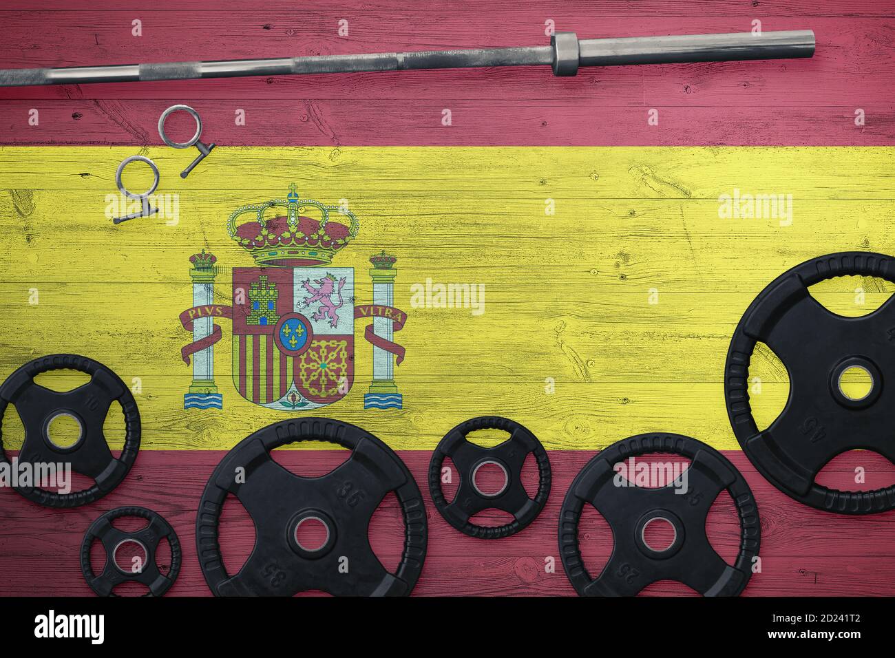 Spain gym concept. Top view of heavy weight plates with iron bar on ...