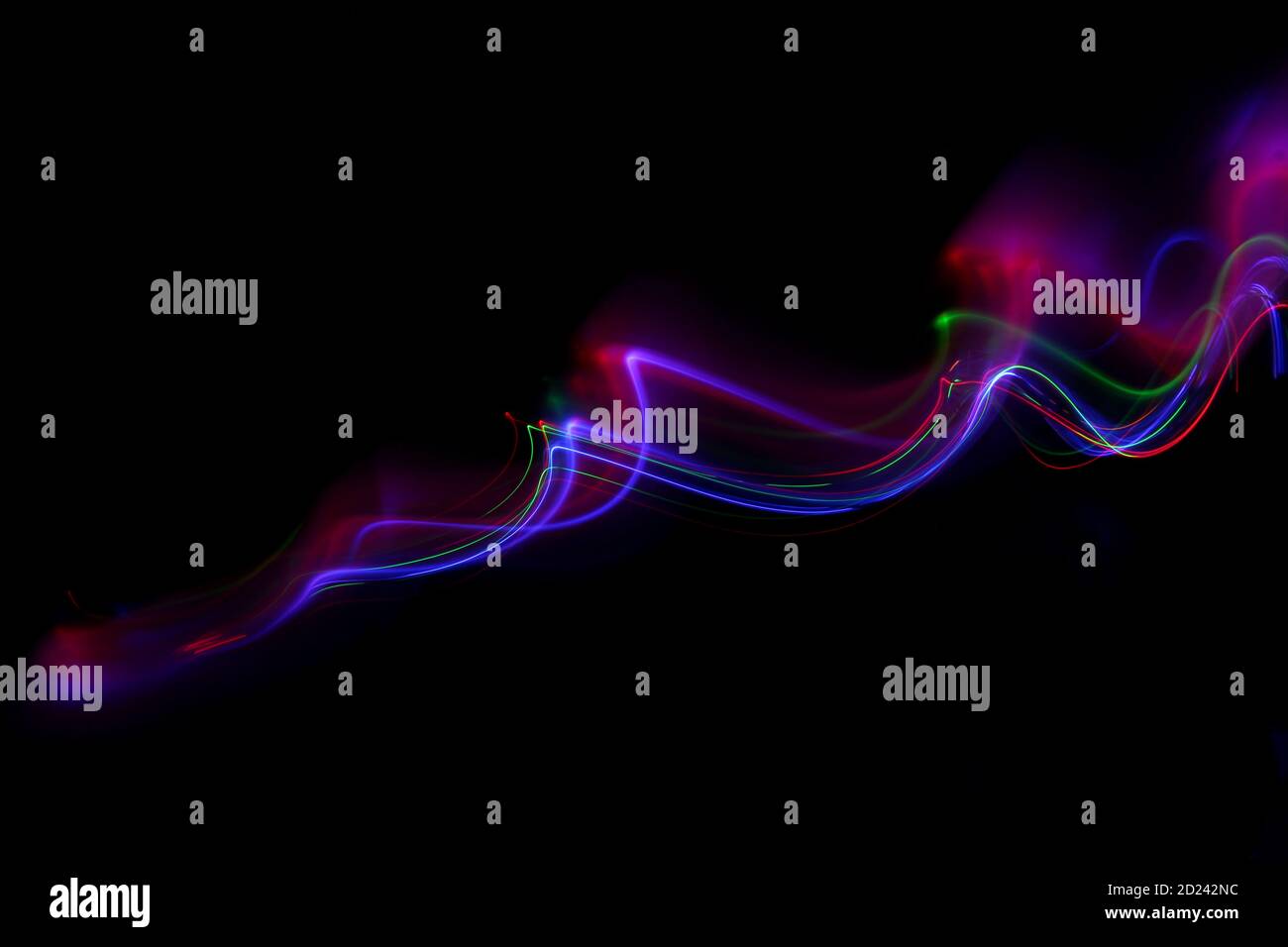 Long exposure photograph of neon colour in an abstract swirl, parallel ...
