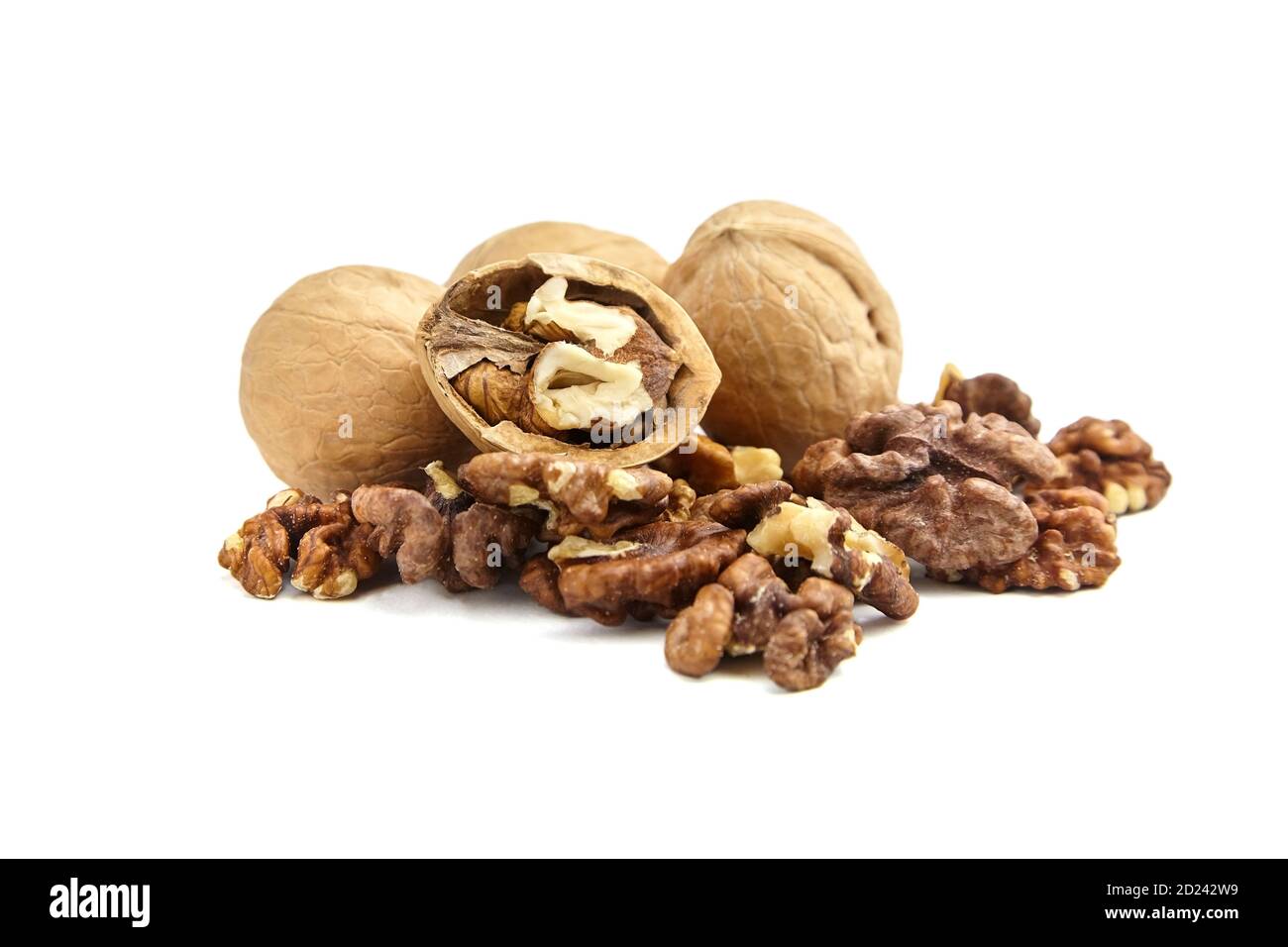 Cracked walnuts heap isolated on white background Stock Photo - Alamy