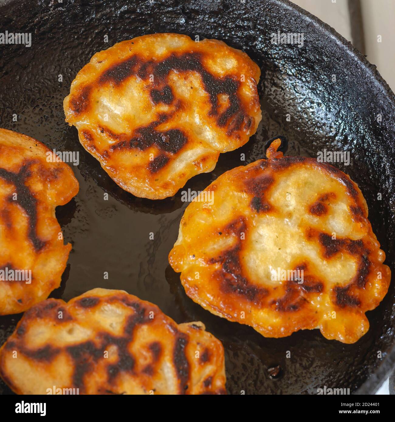 Burnt pancakes in a frying pan. A serving of homemade refried tortillas ...