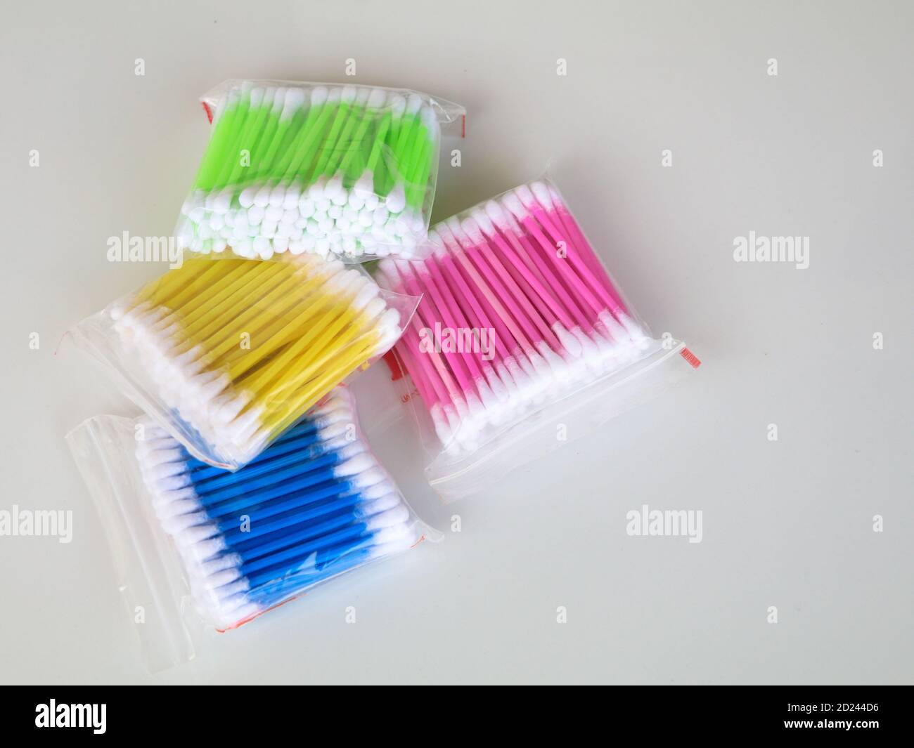 Multi colored ear cleaning buds in packets, against white background ...
