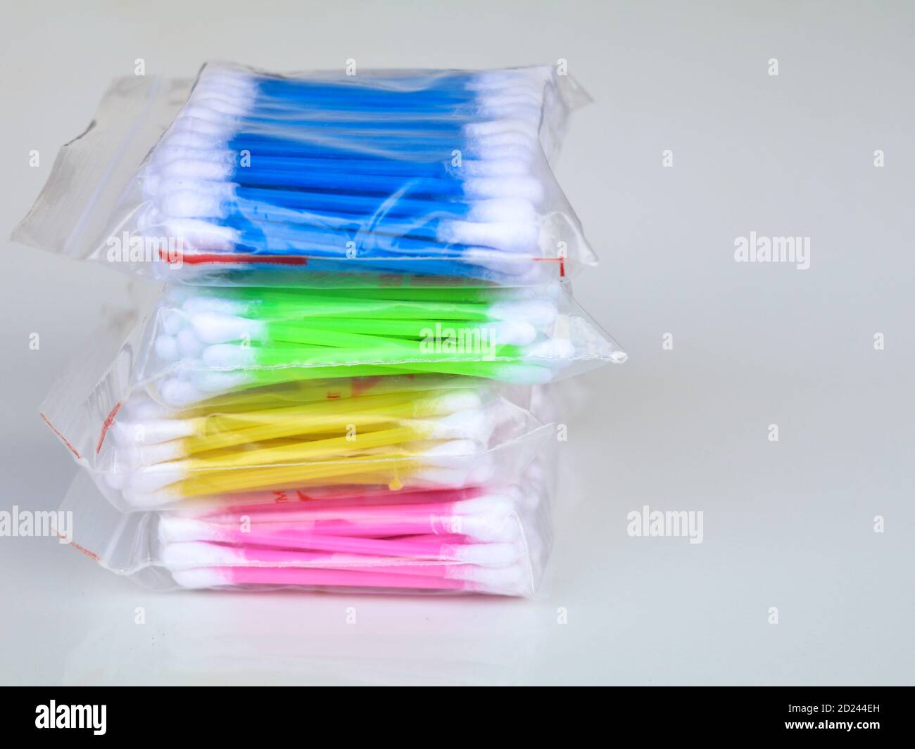 Multi colored ear cleaning buds in packets, against white background ...
