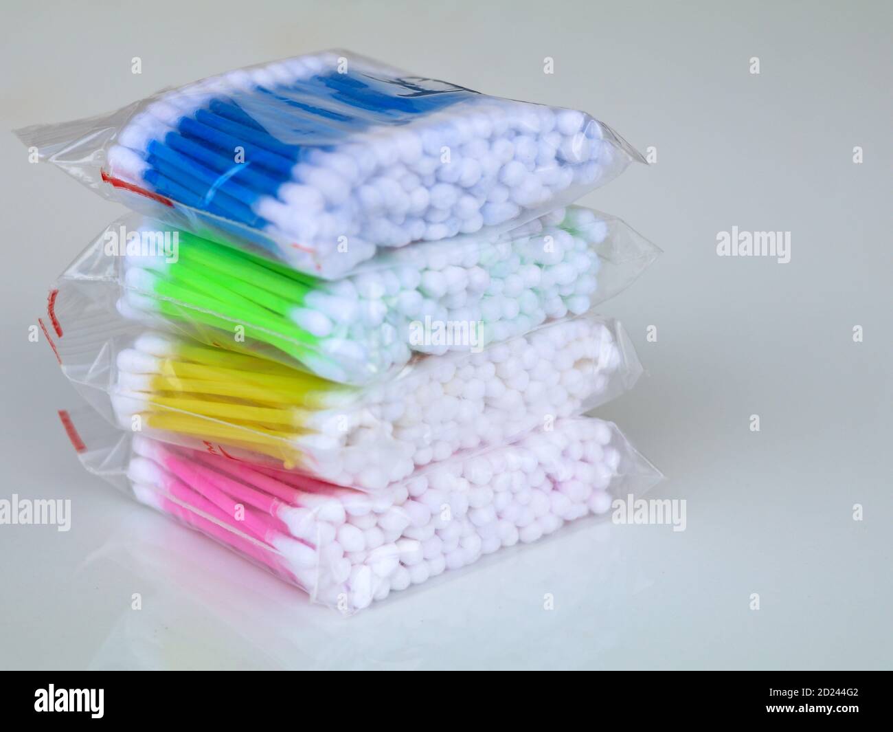 Multi colored ear cleaning buds in packets, against white background ...