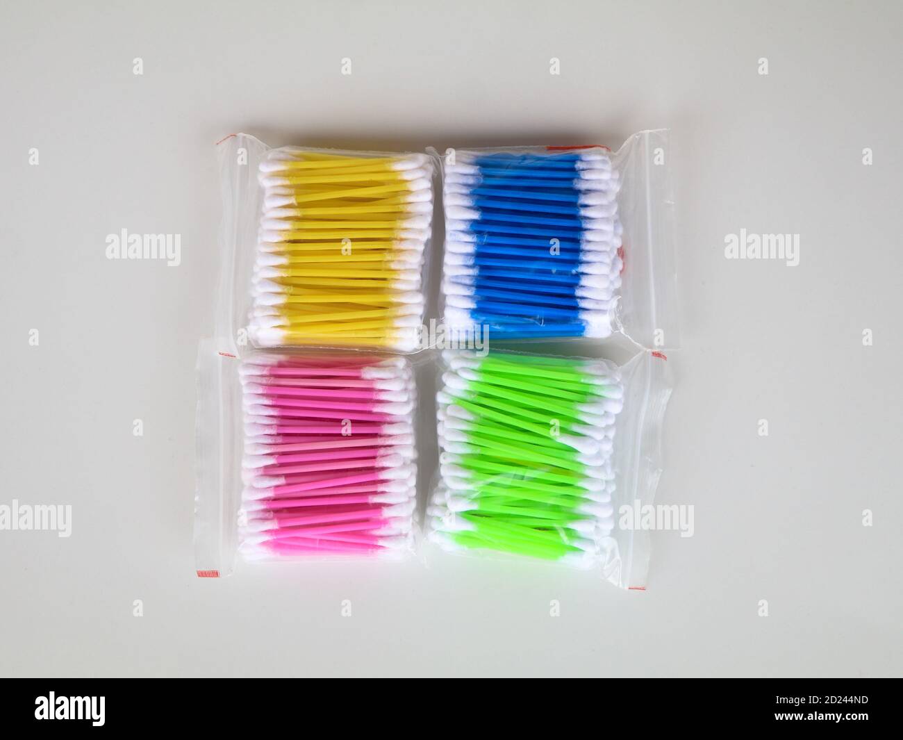 Multi colored ear cleaning buds in packets, against white background ...