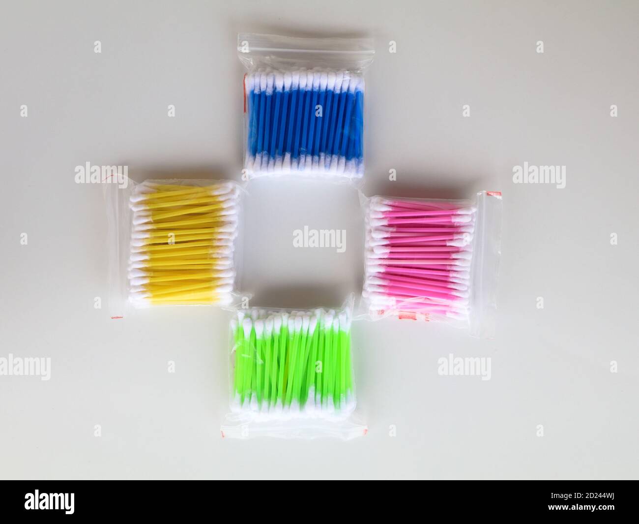 Multi colored ear cleaning buds in packets, against white background ...