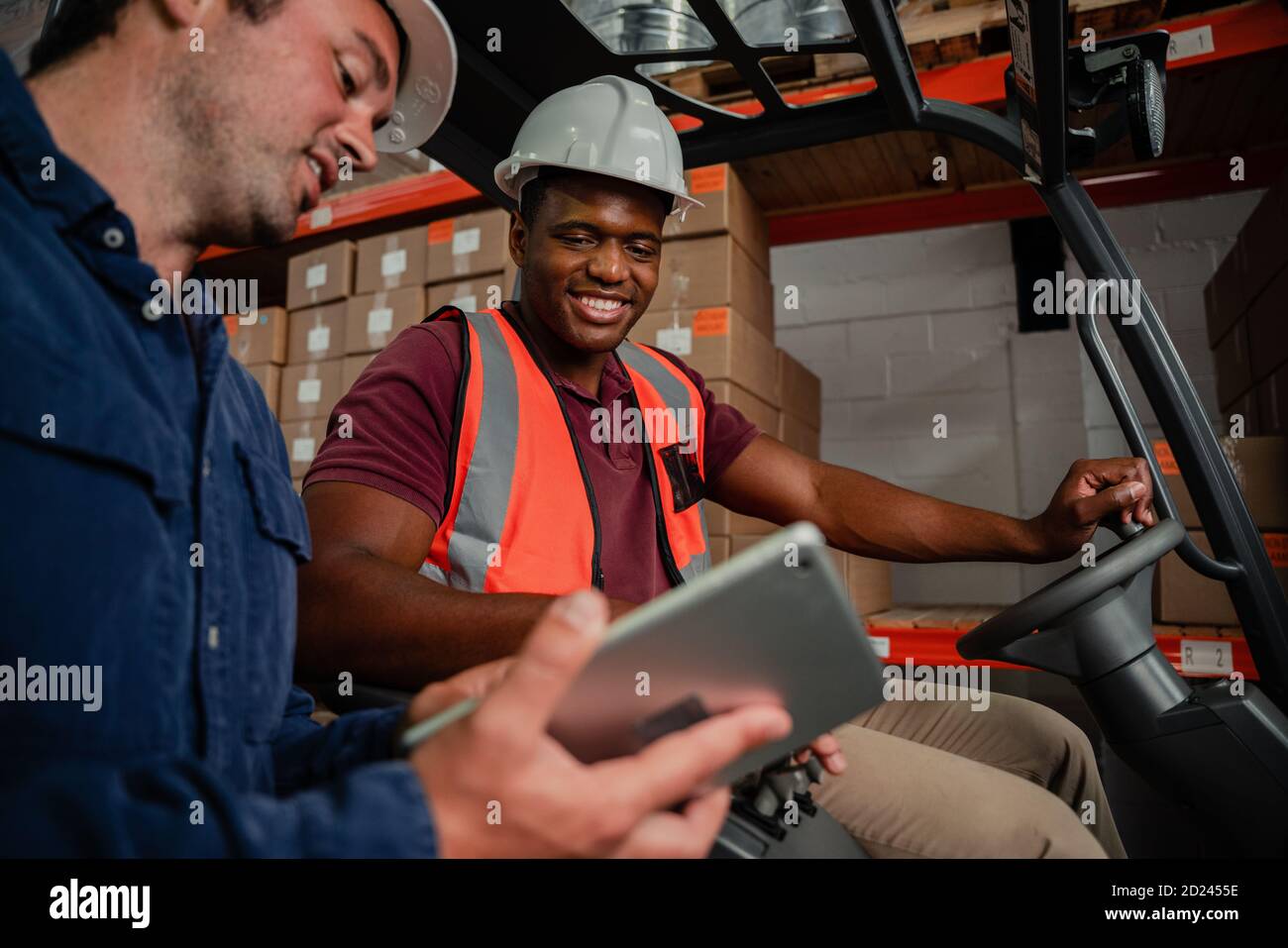 Caucasian worker holding digital tablet showing ethnic worker location ...