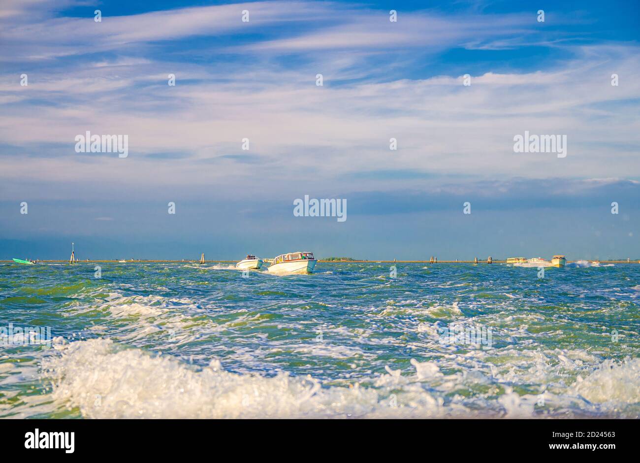 Yacht boats racing sailing on water of Venetian lagoon between wooden ...