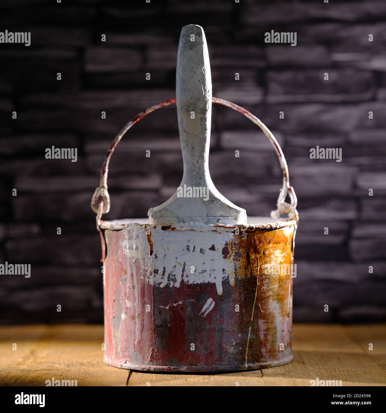 Paint tin bucket splattered with red and white paint with old paint ...