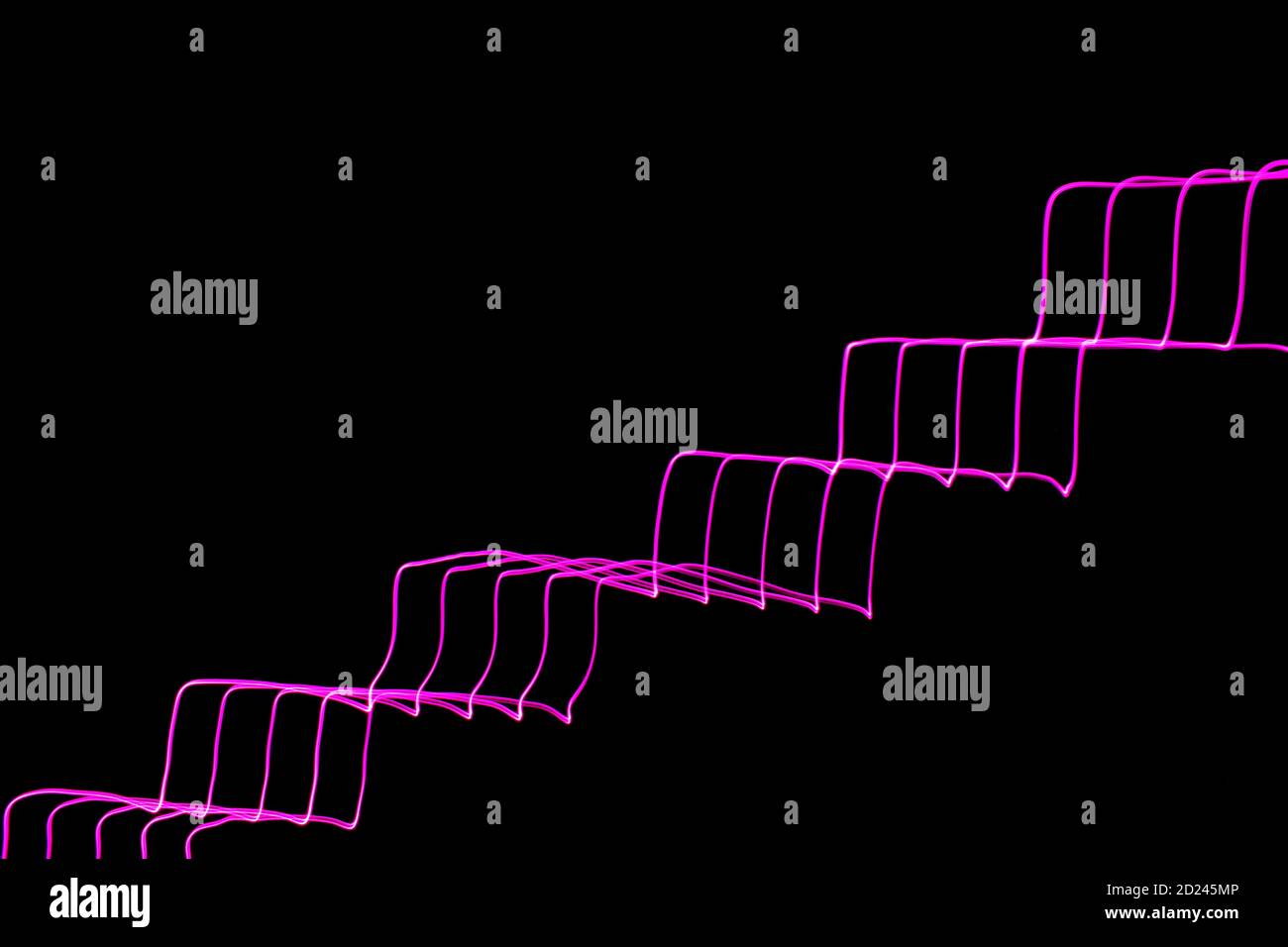 Long exposure photograph of neon colour in an abstract swirl, parallel ...