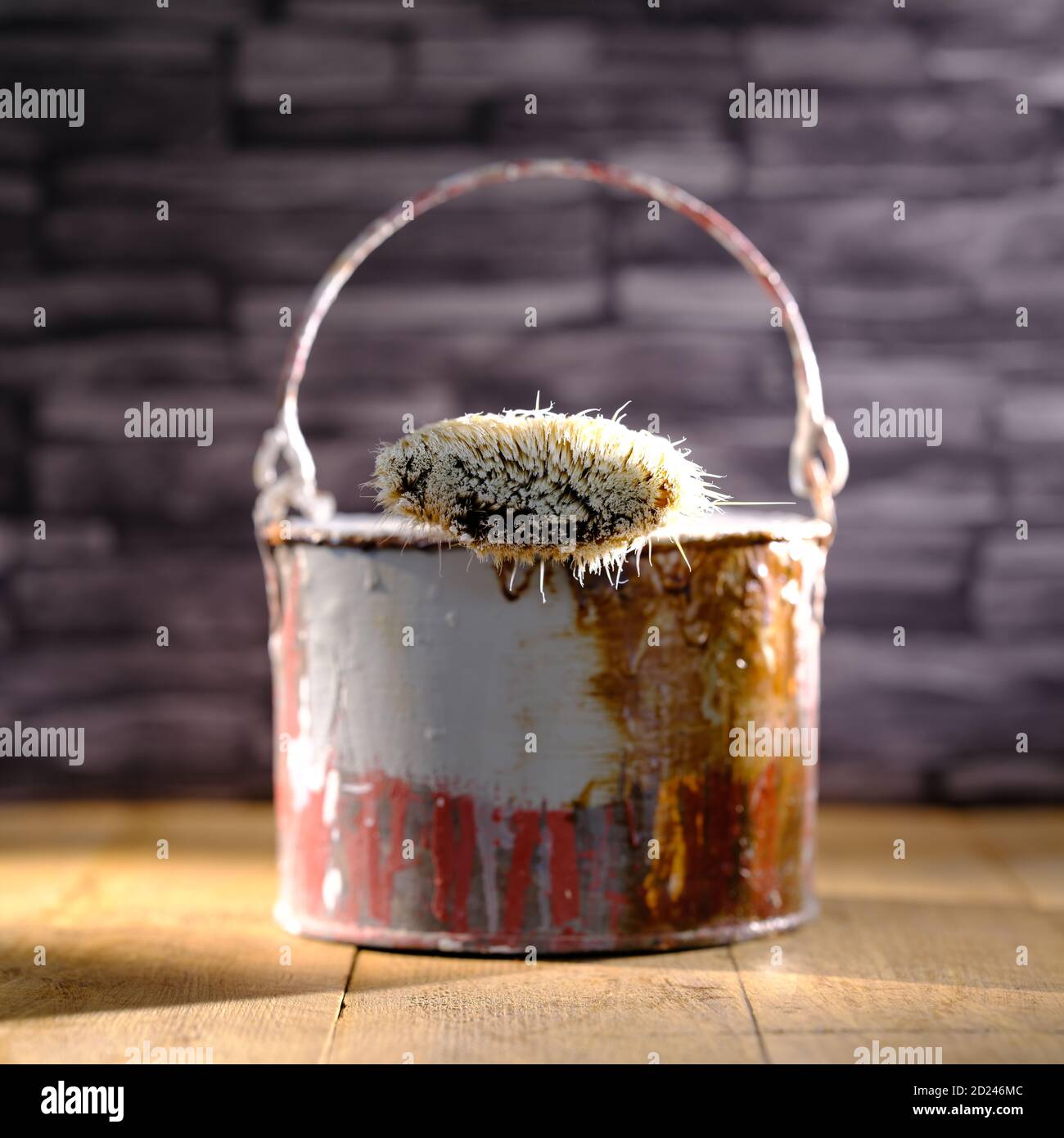 Paint tin bucket splattered with red and white paint with old paint ...