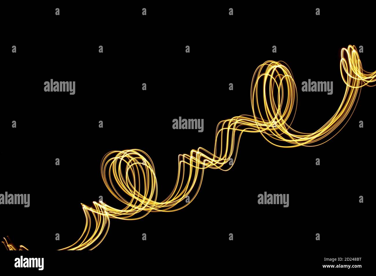 Long exposure photograph of neon colour in an abstract swirl, parallel ...