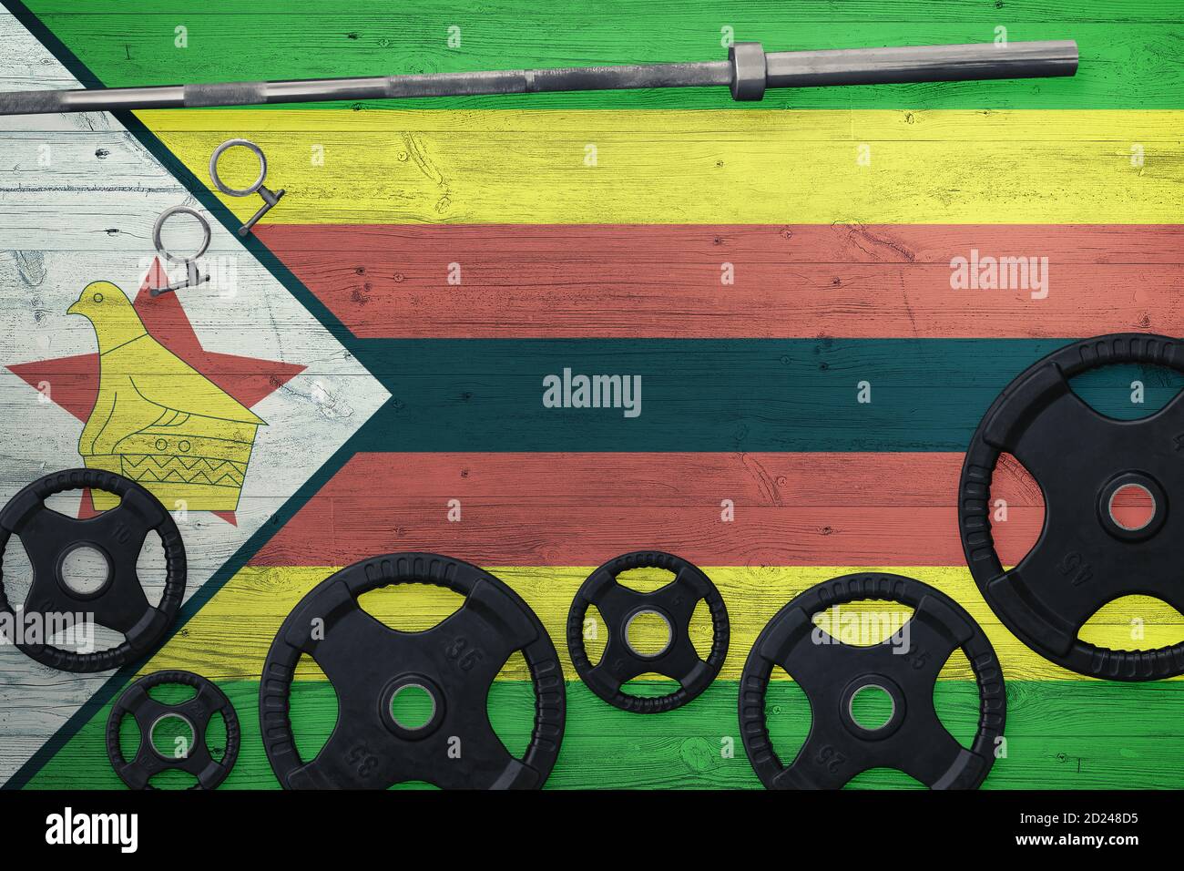 Zimbabwe gym concept. Top view of heavy weight plates with iron bar on ...