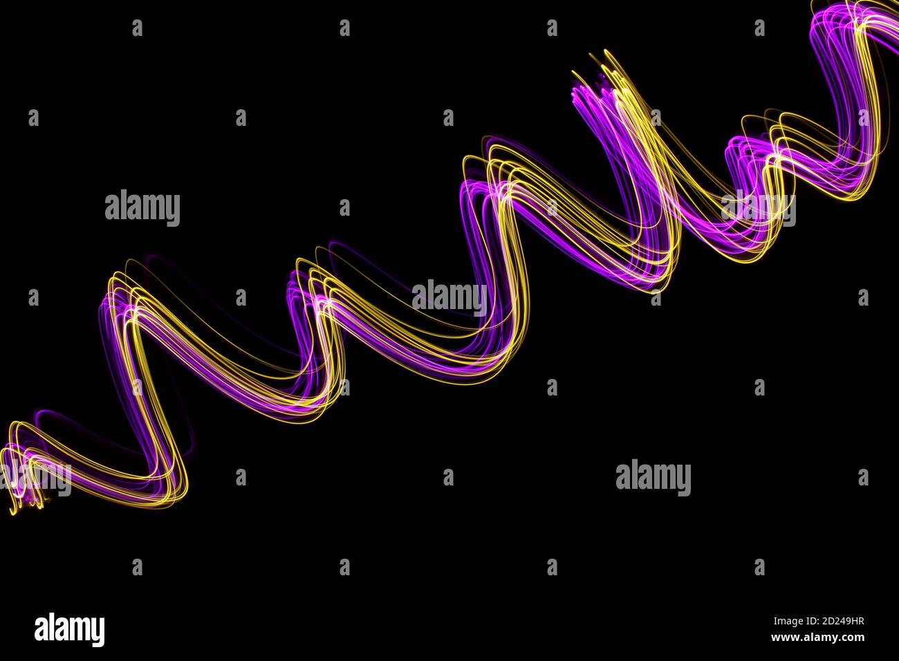 Long exposure photograph of neon colour in an abstract swirl, parallel ...
