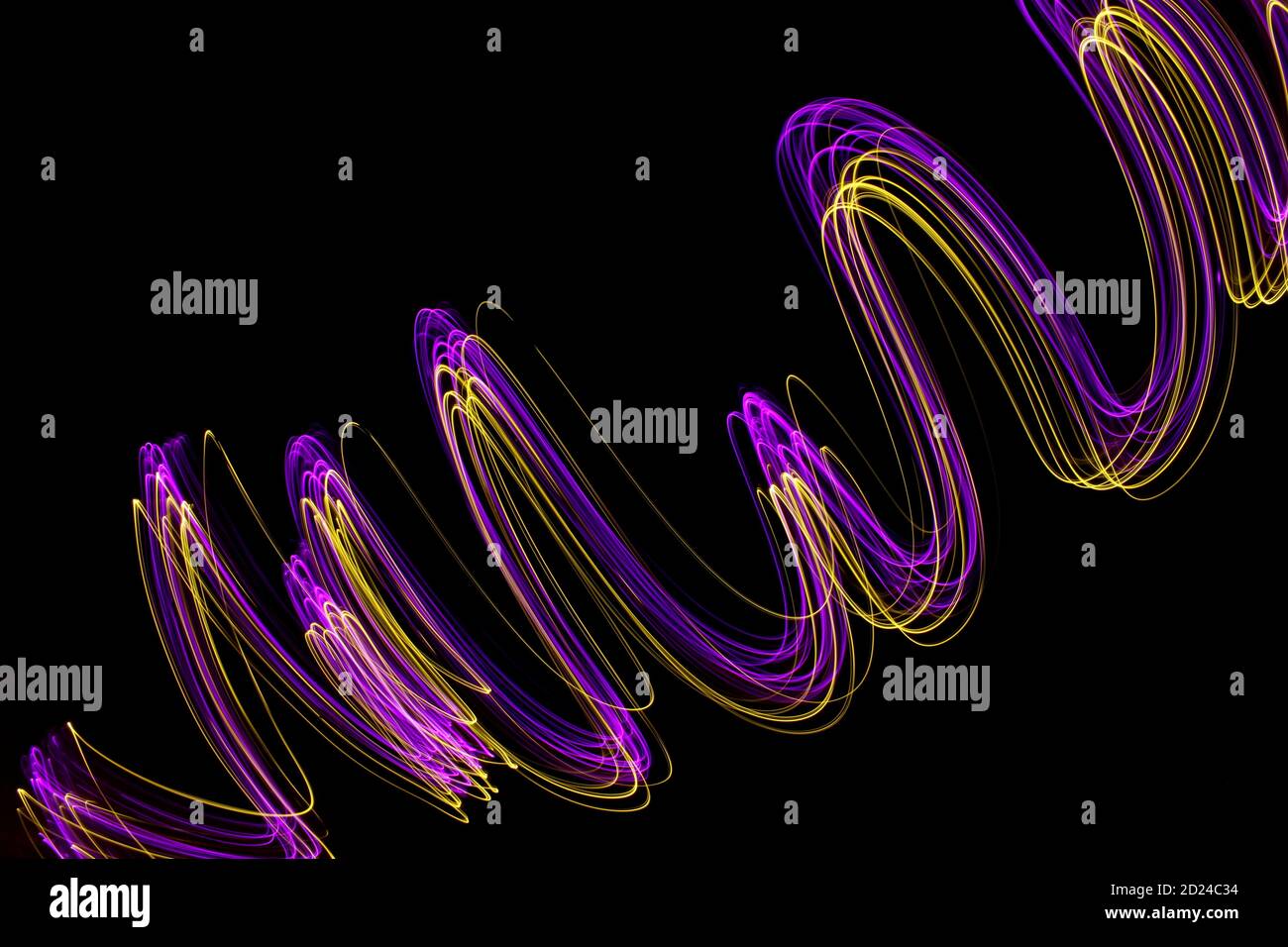 Long exposure photograph of neon colour in an abstract swirl, parallel ...