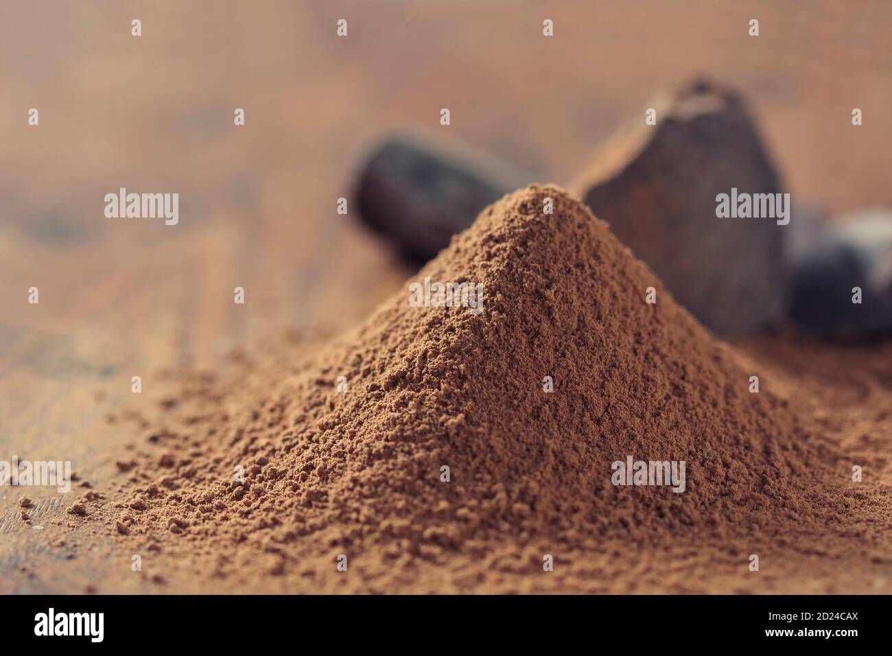 dark chocolate, cocoa solids and cocoa powder over wooden background ...