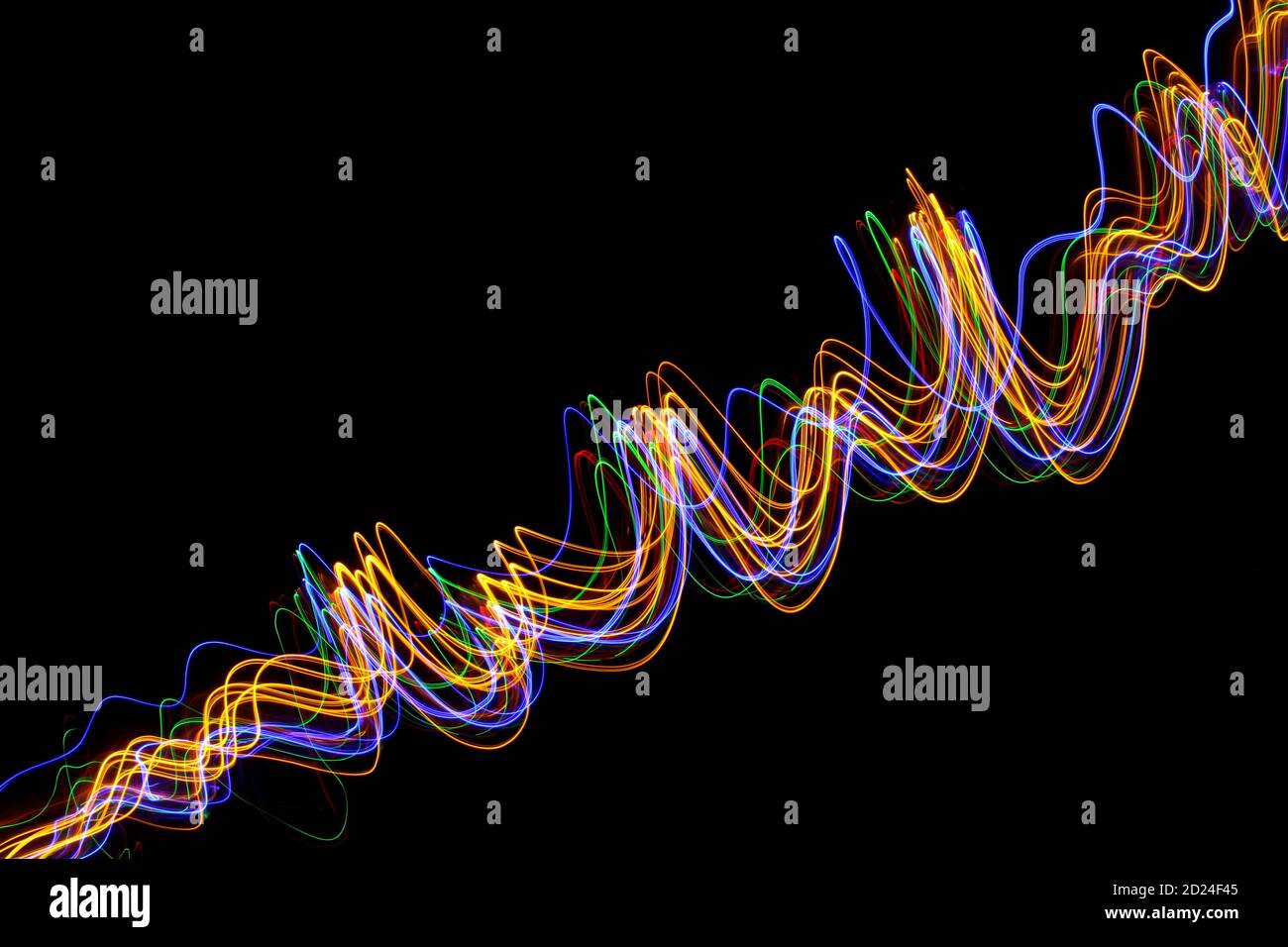 Long exposure photograph of neon colour in an abstract swirl, parallel ...