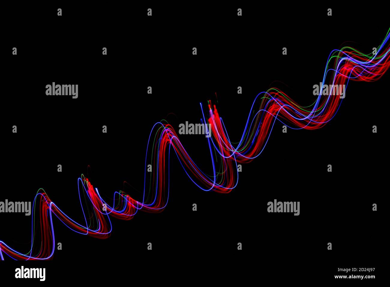 Long exposure photograph of neon colour in an abstract swirl, parallel ...