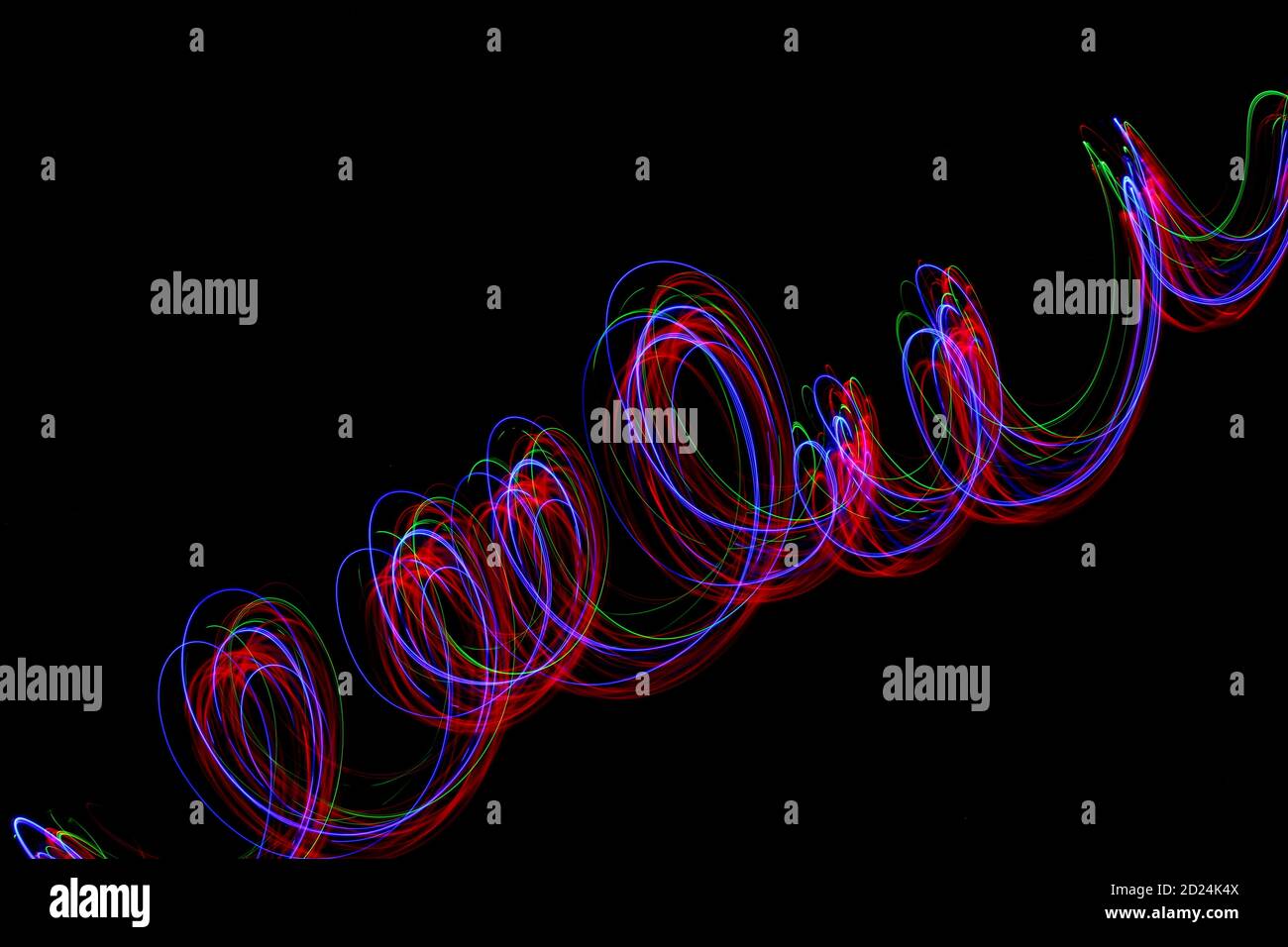 Long exposure photograph of neon colour in an abstract swirl, parallel ...