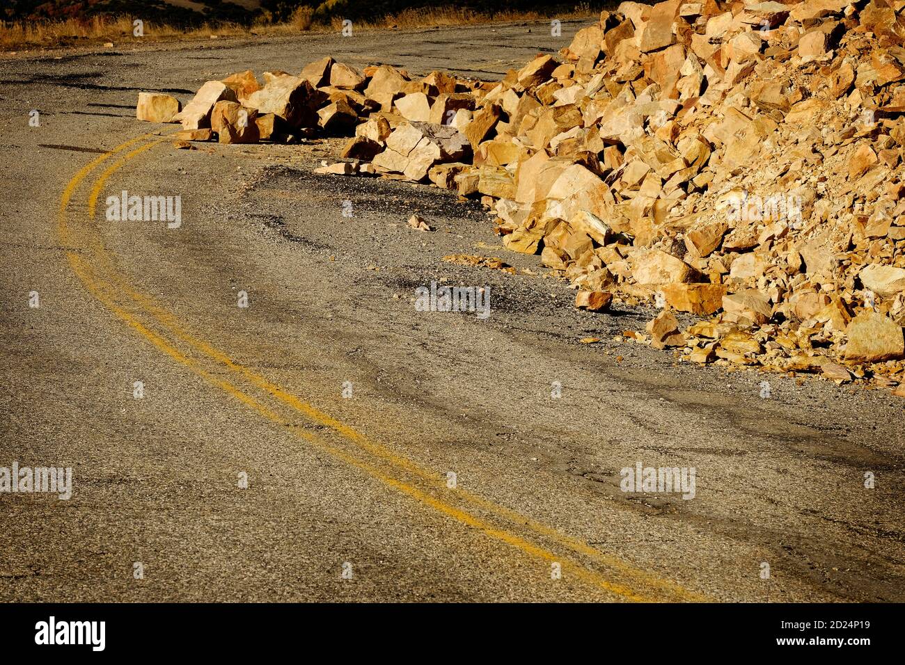Rock avalance on road roadway drive Stock Photo - Alamy