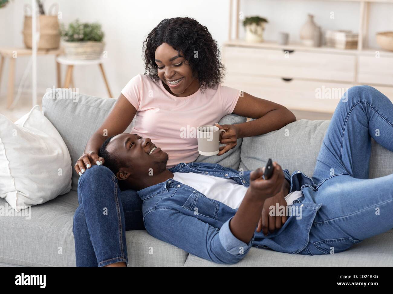Loving black man and woman enjoying weekend at home together Stock ...