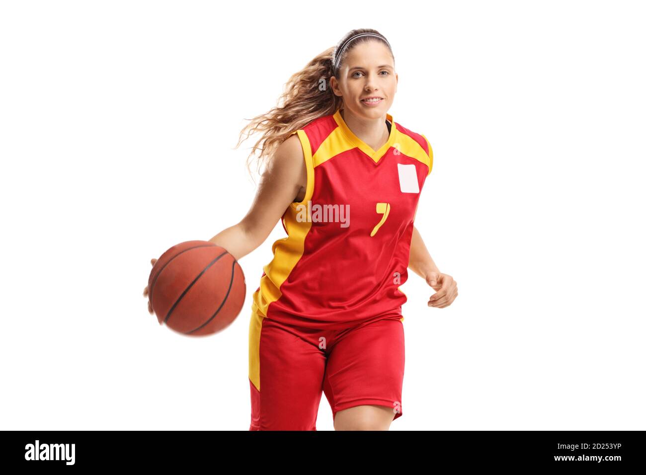 Female basketball player in a red jersey running with a ball isolated ...