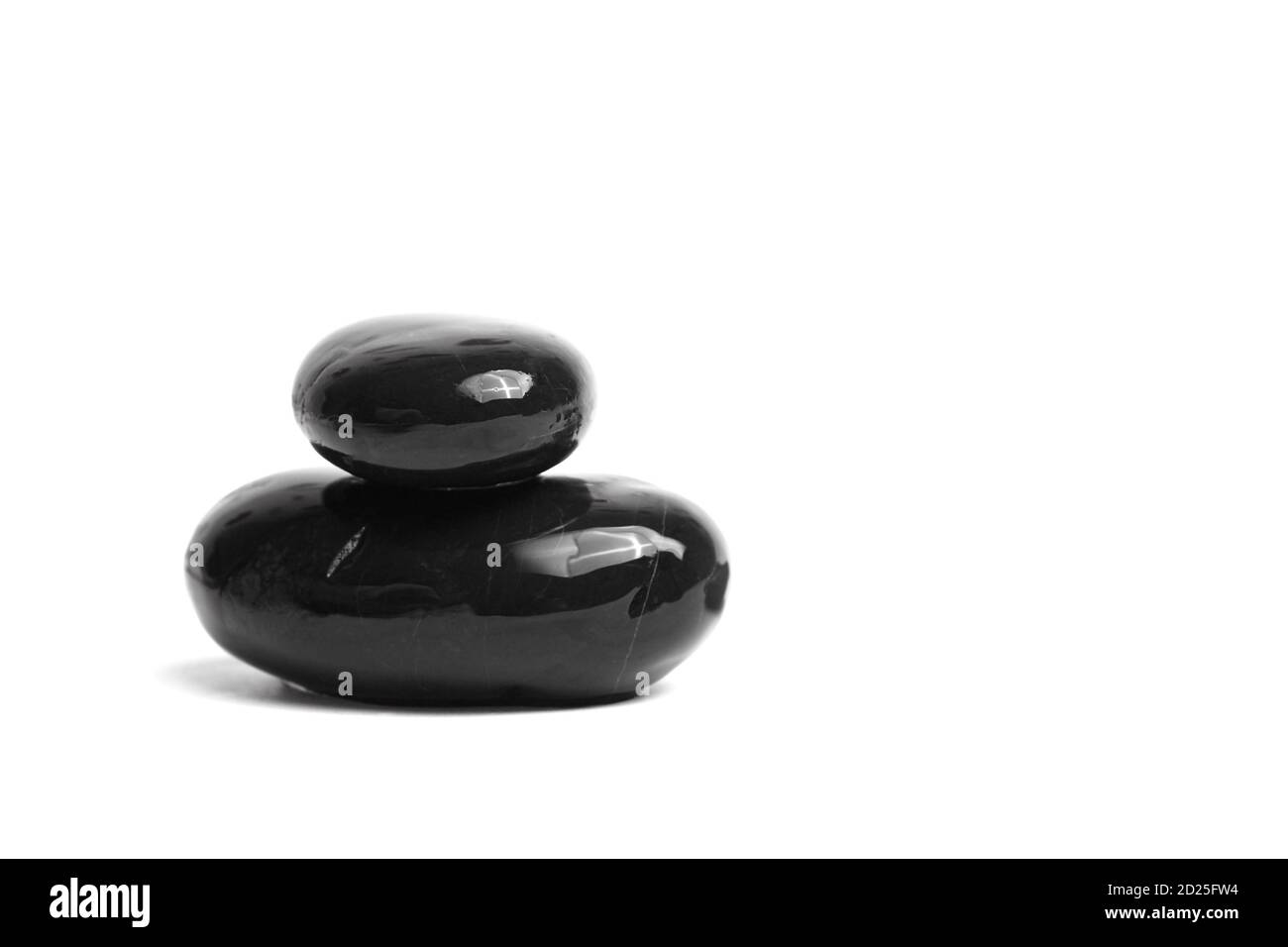 Stacked smooth black stones. Sea pebble. Balancing wet pebbles isolated ...