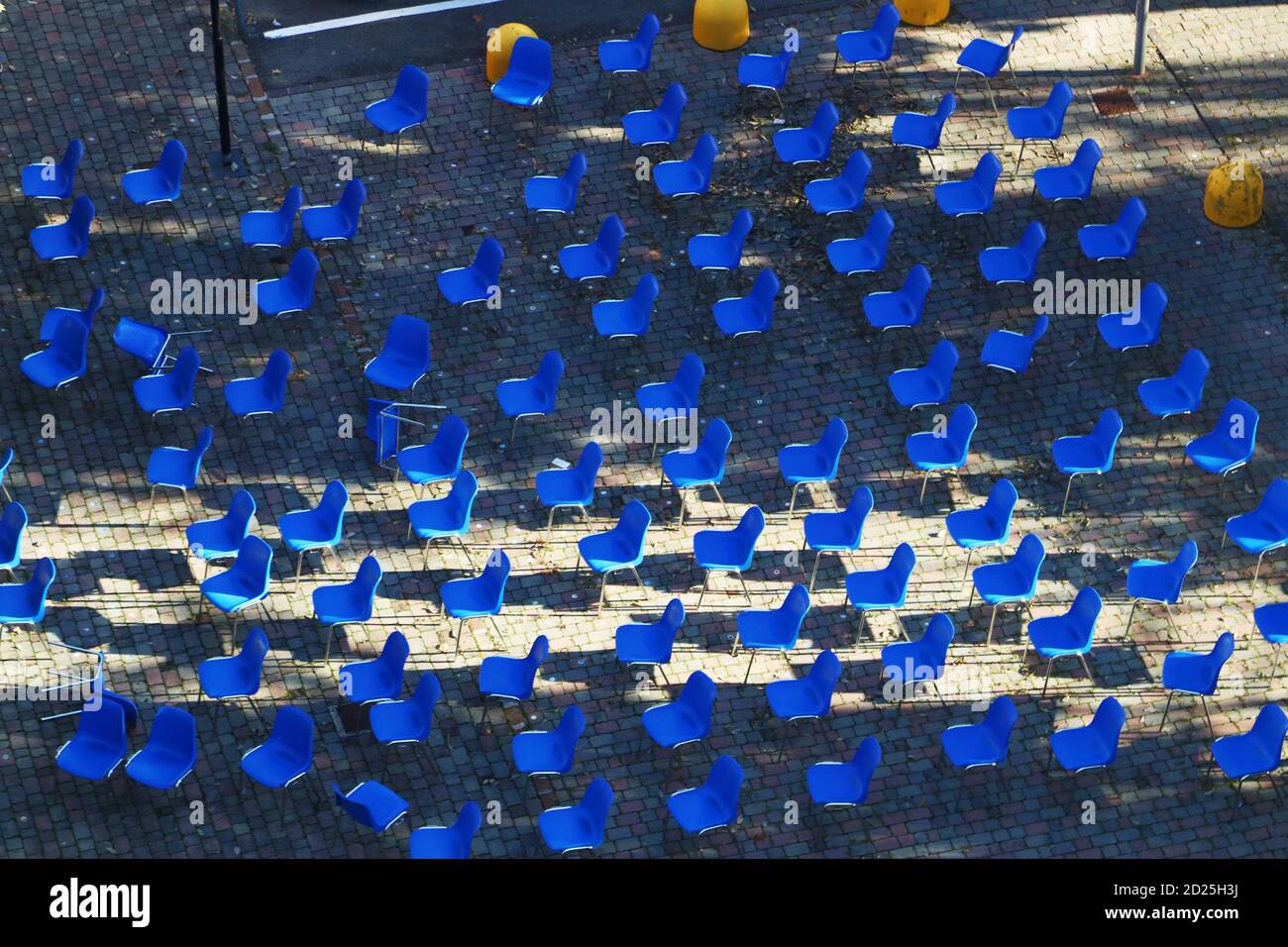 Group of blue chairs in a square after a public meeting Stock Photo - Alamy