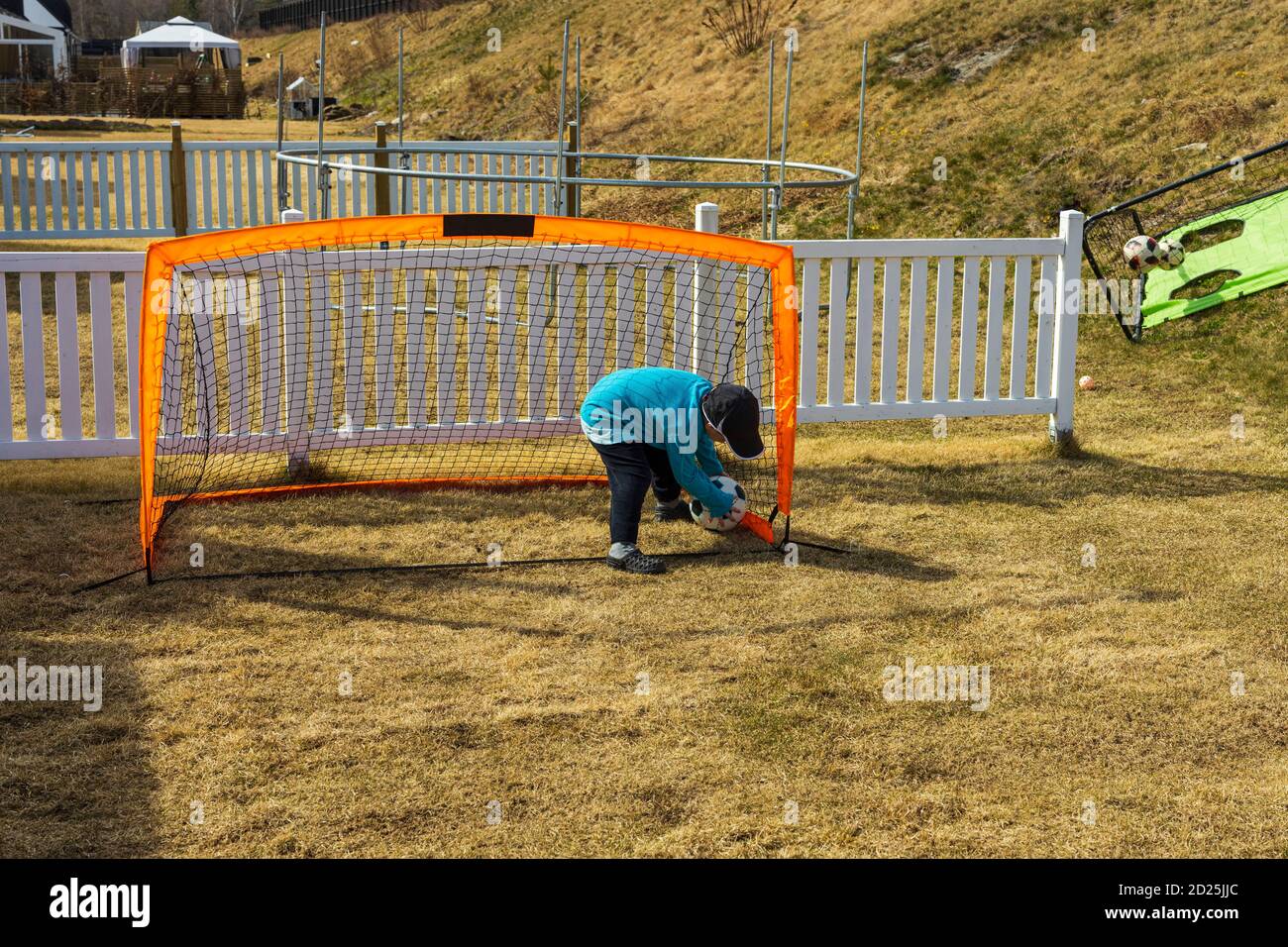 Stay at home. COVID 19. Close up view of boy playing football on ...
