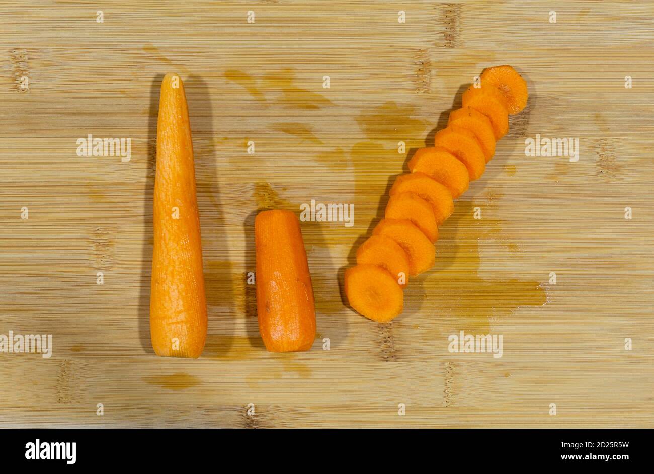 3 cleaning carrots on a cutting board Stock Photo - Alamy