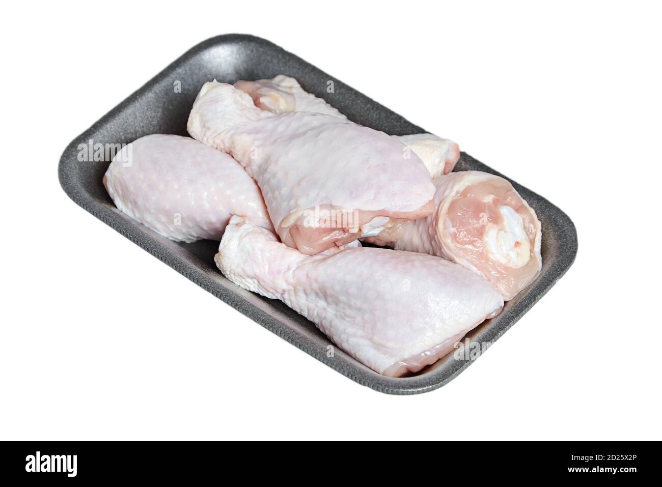 Raw and uncooked chicken legs with skin in a grey plastic container ...