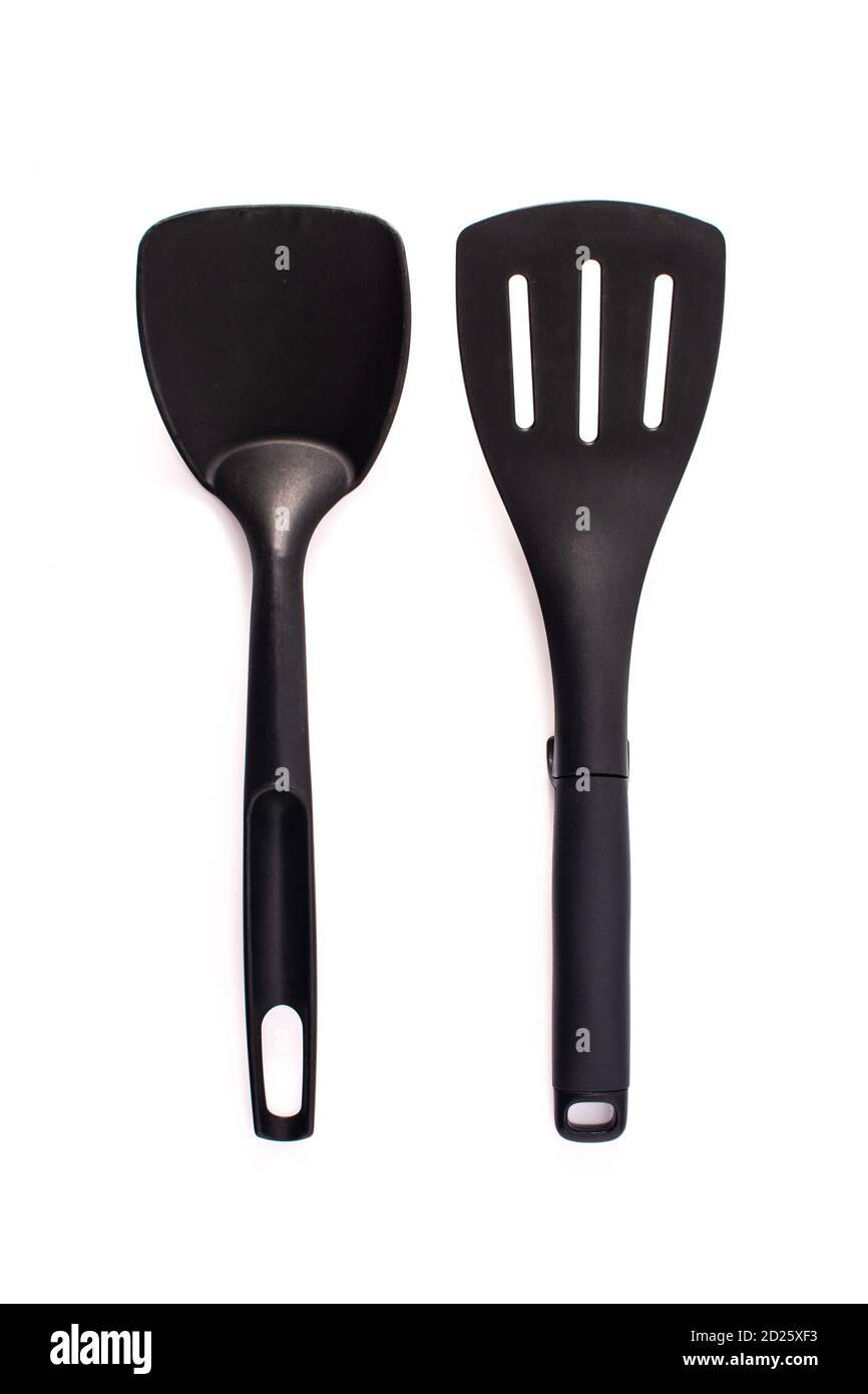 Black plastic kitchen spatula and spoon isolated on white background ...