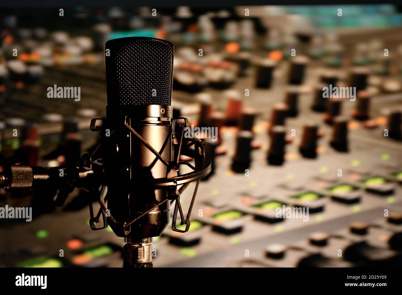 Condenser microphone with mixing desk in the background Stock Photo - Alamy