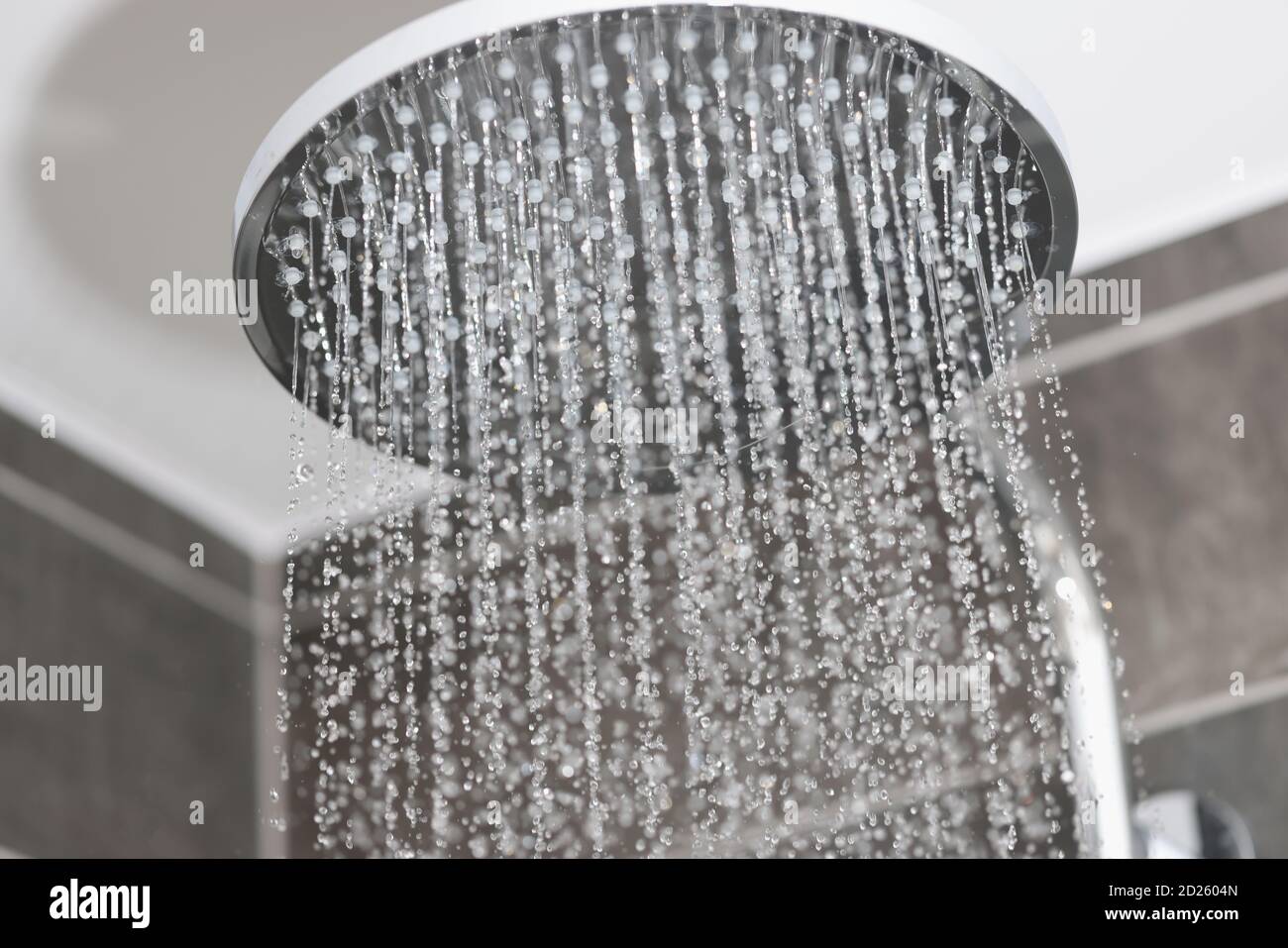 Close-up of water flows in small jets from metal rain shower in ...