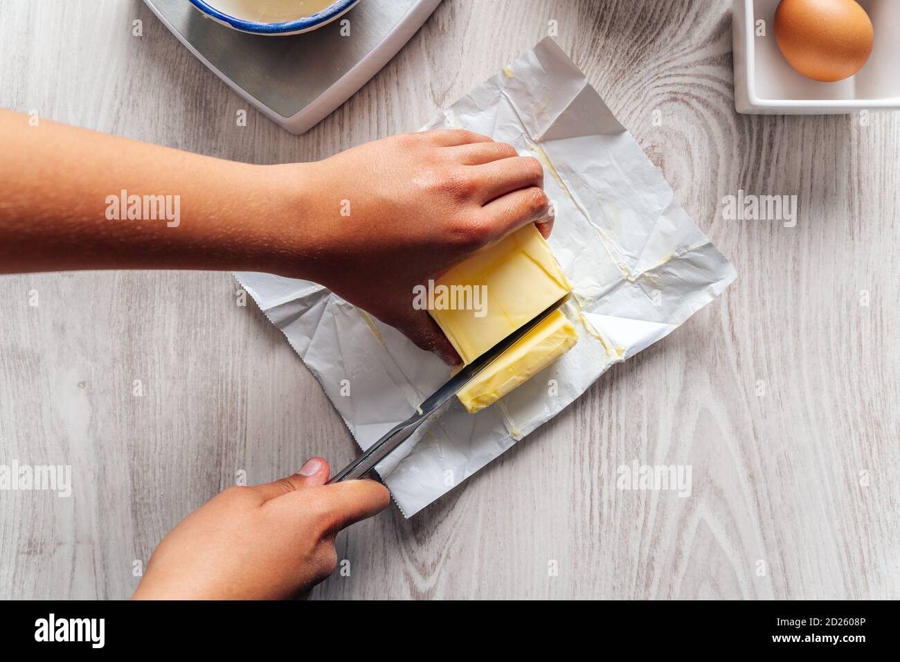 Hands cutting a piece of butter with a knife Stock Photo - Alamy