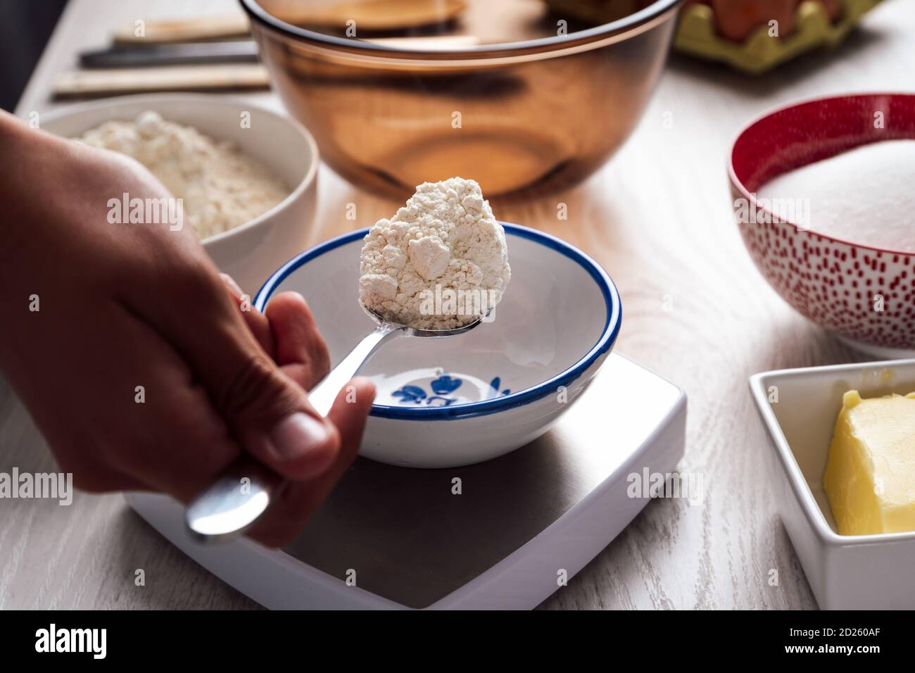 Flour in a spoon before weighing it Stock Photo - Alamy