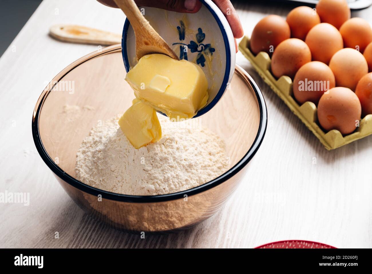 Hands pouring butter into a bowl of flour Stock Photo - Alamy
