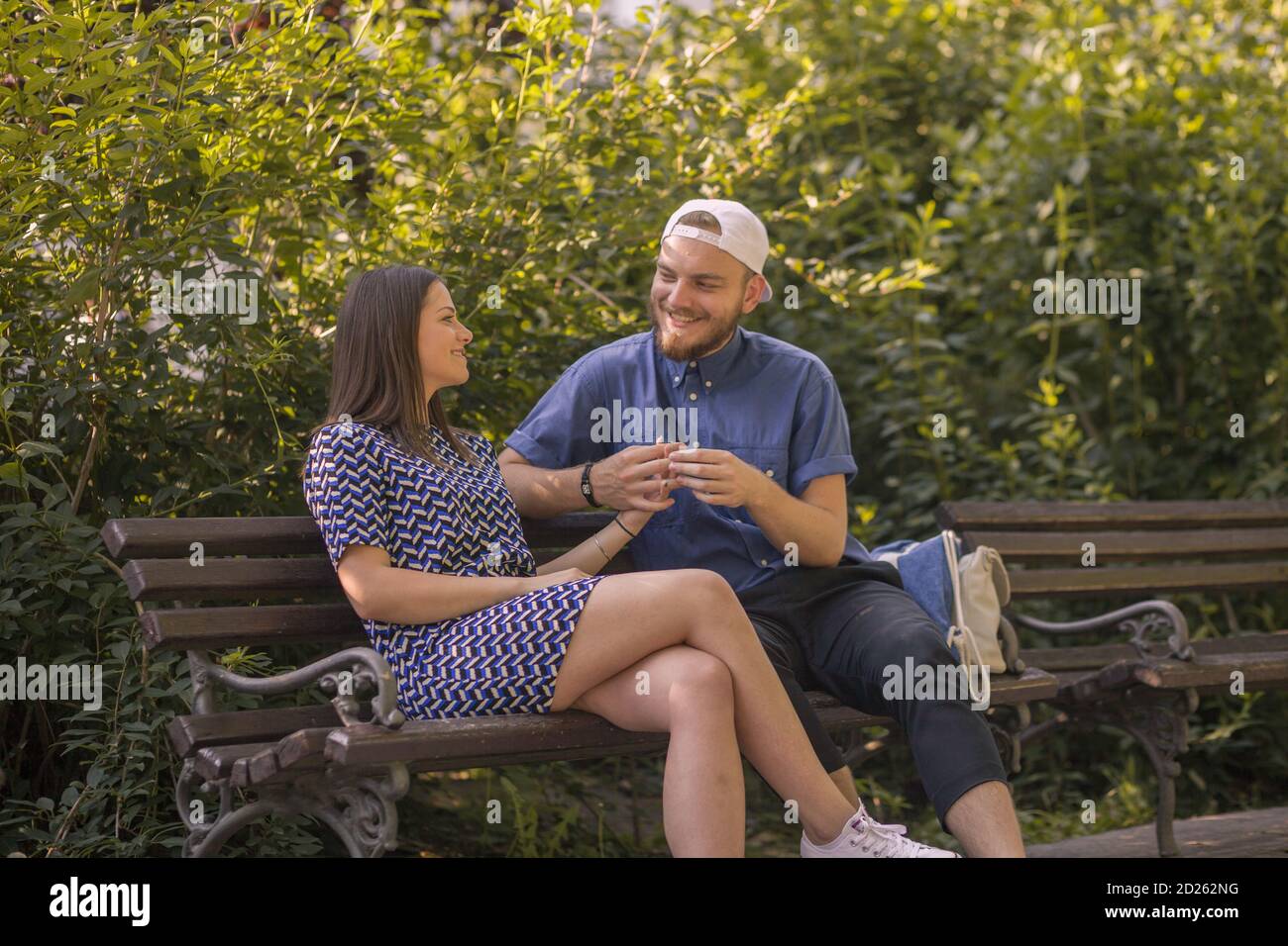 Happy young couple enjoys spring day in park. Holding hands Stock Photo ...