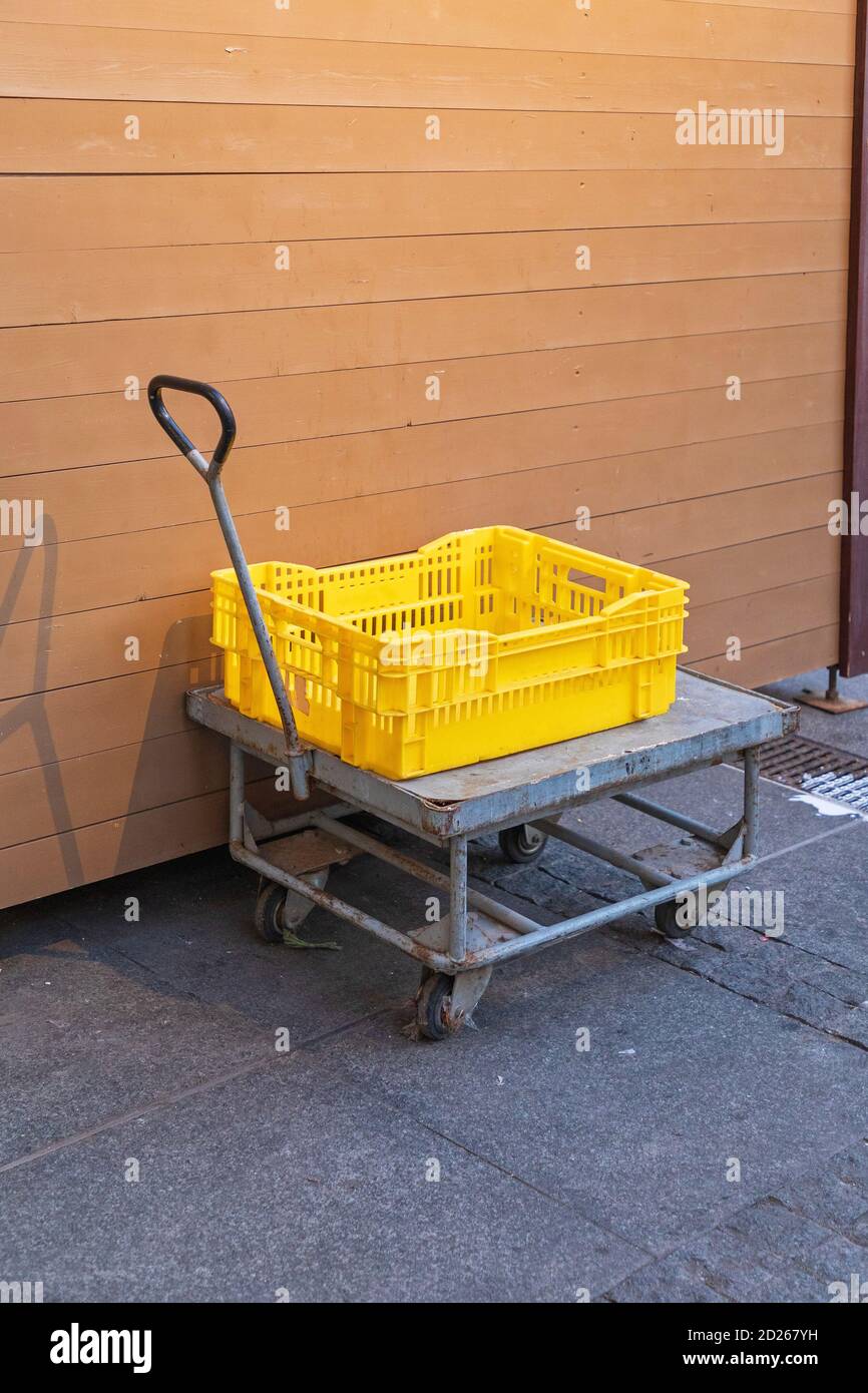 Yellow Plastic Crate at Cart Dolly Transport Stock Photo - Alamy