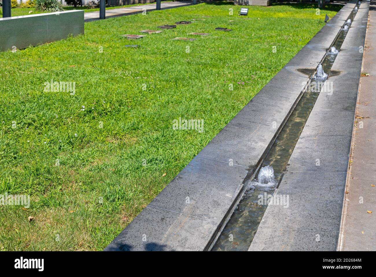 Long Fountain With Water Flow in Park Stock Photo - Alamy