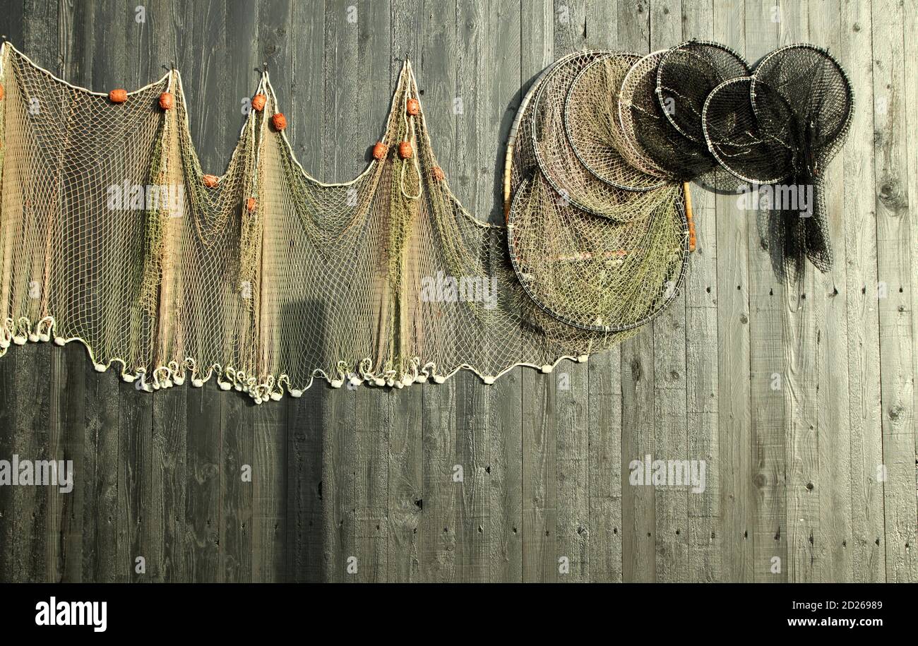 fishing net hanging on a wall Stock Photo - Alamy